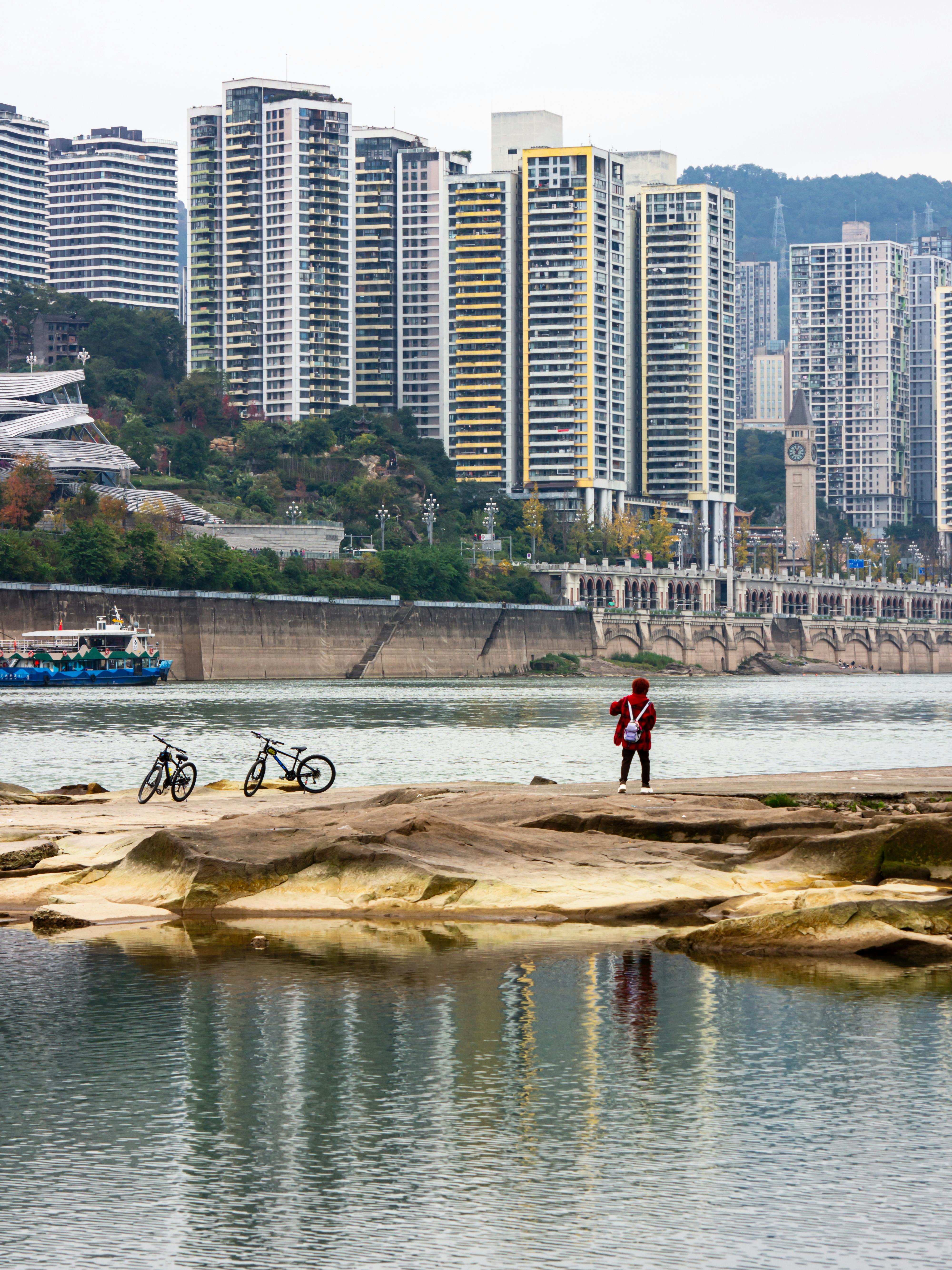Urban Riverfront with High-Rise Skyline · Free Stock Photo