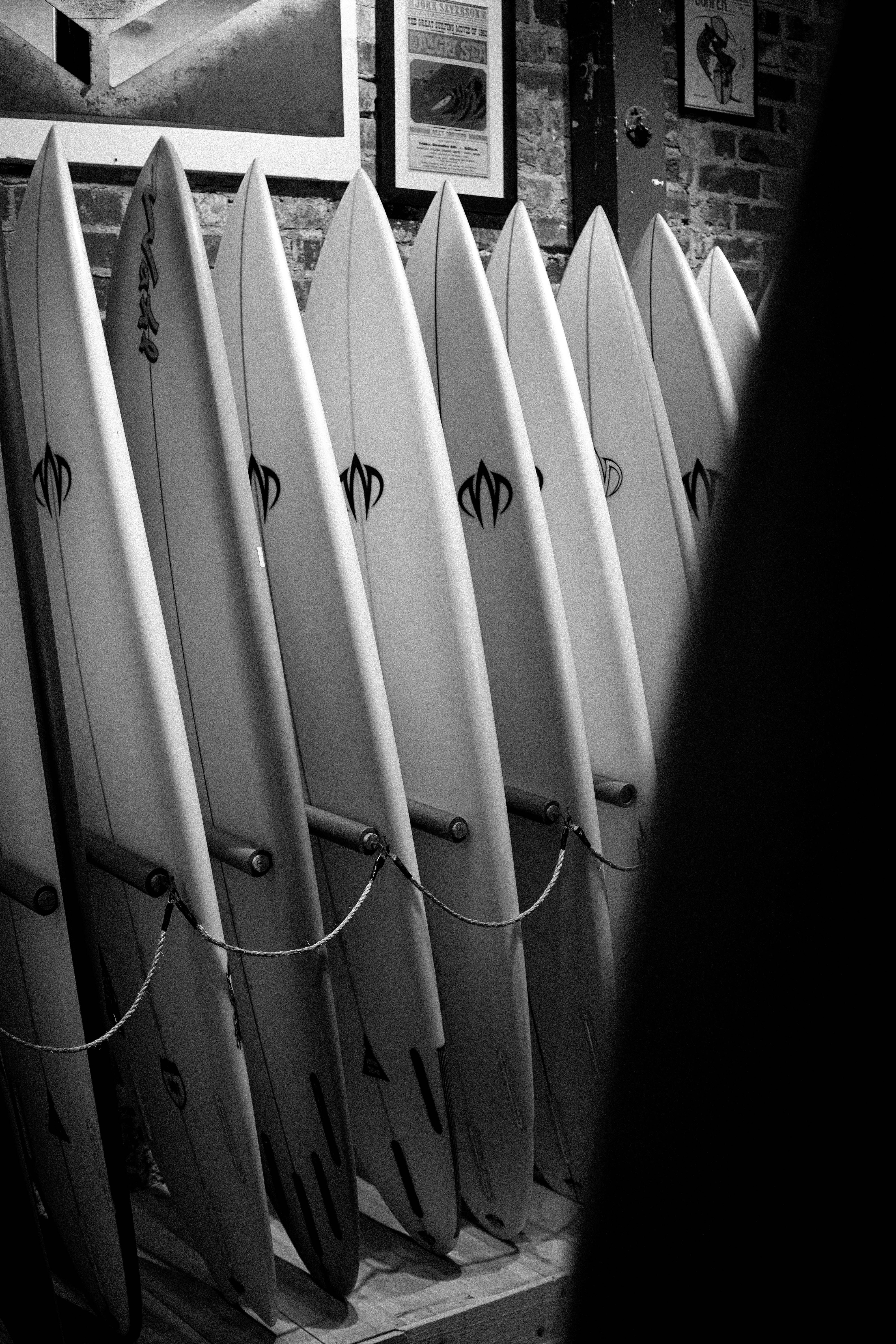Black and White Surfboards in Surf Shop Display · Free Stock Photo