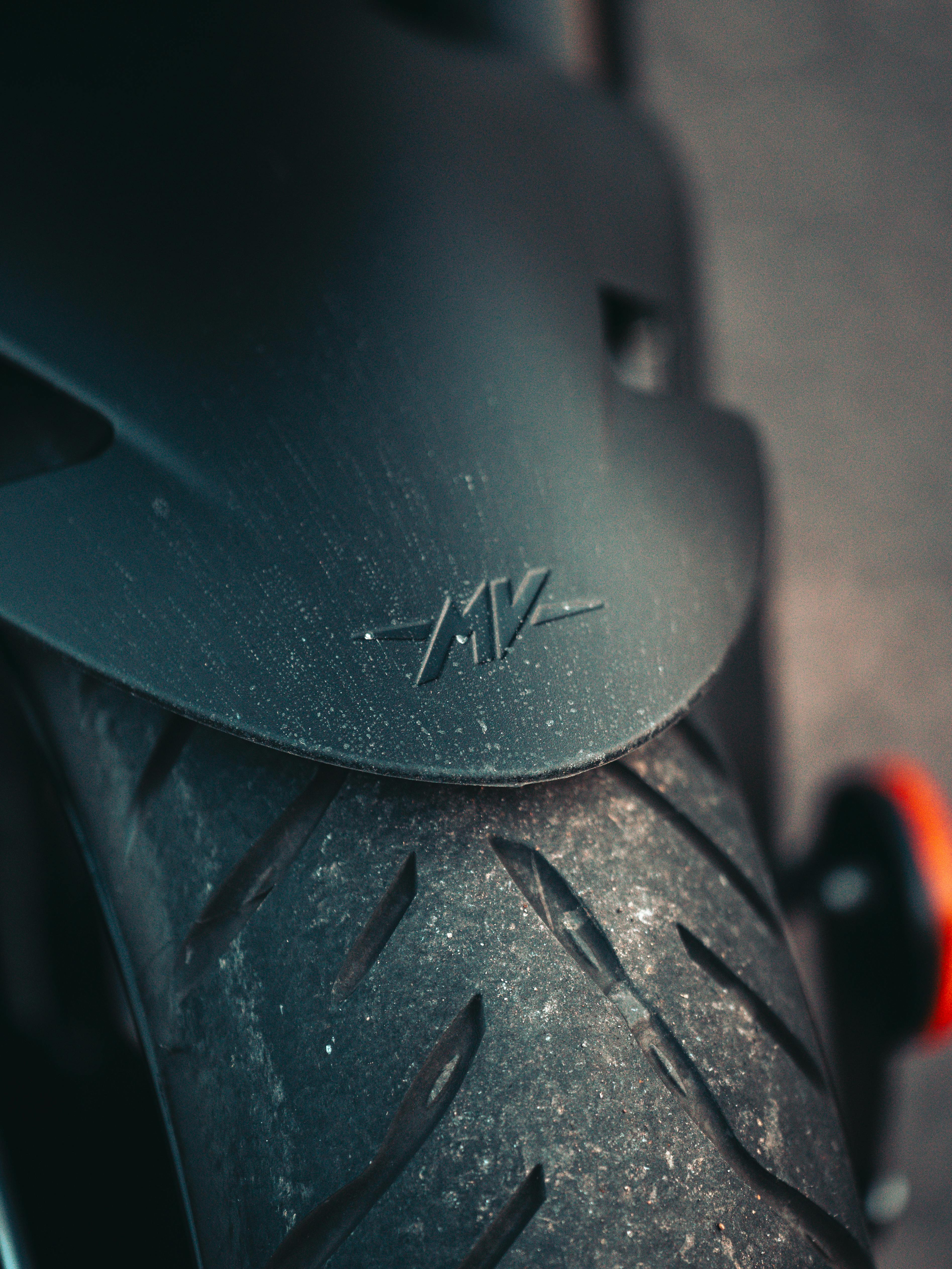 Close-up View of Motorcycle Tire with Tread Pattern · Free Stock Photo