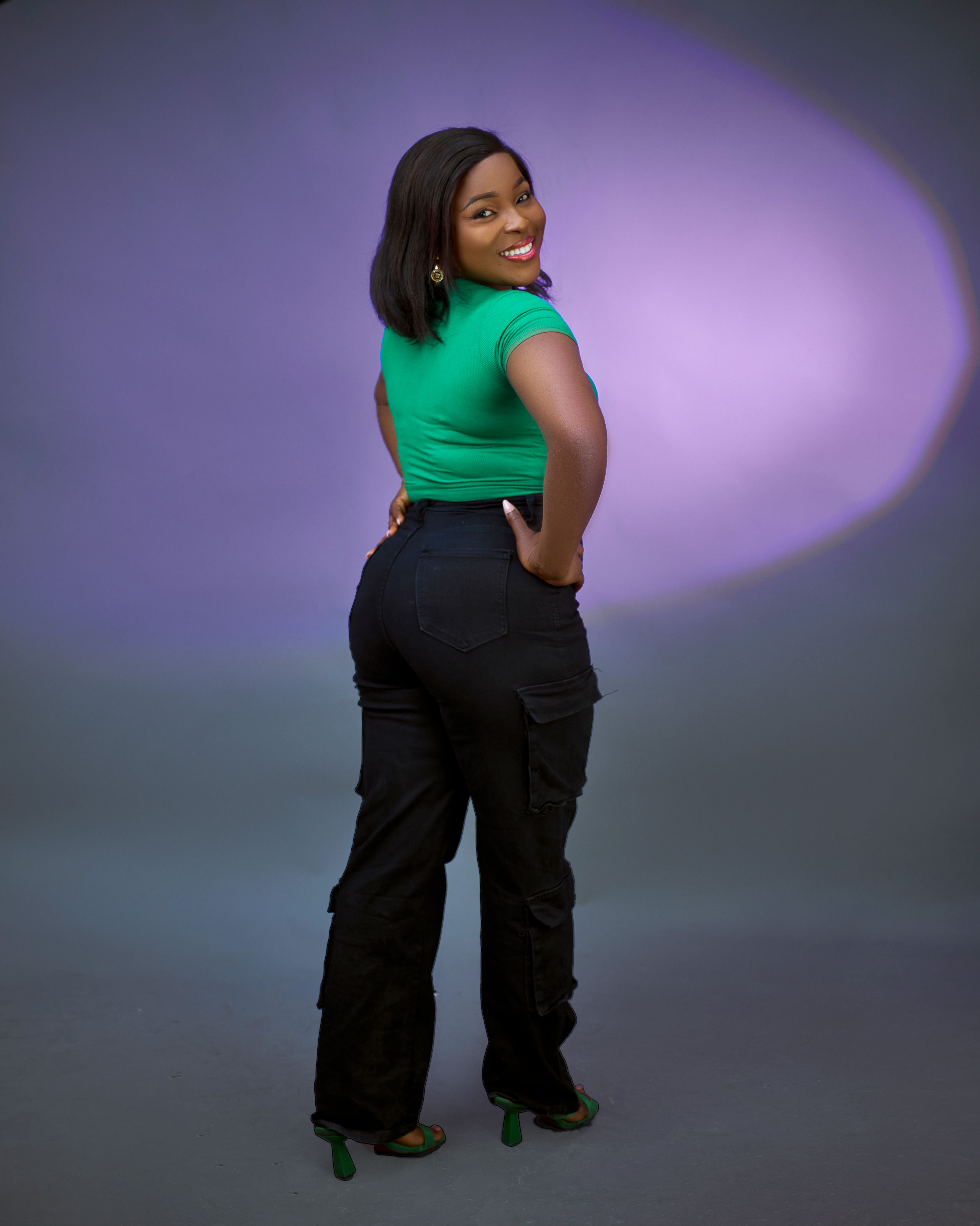 Confident Woman Posing in Studio Back View · Free Stock Photo