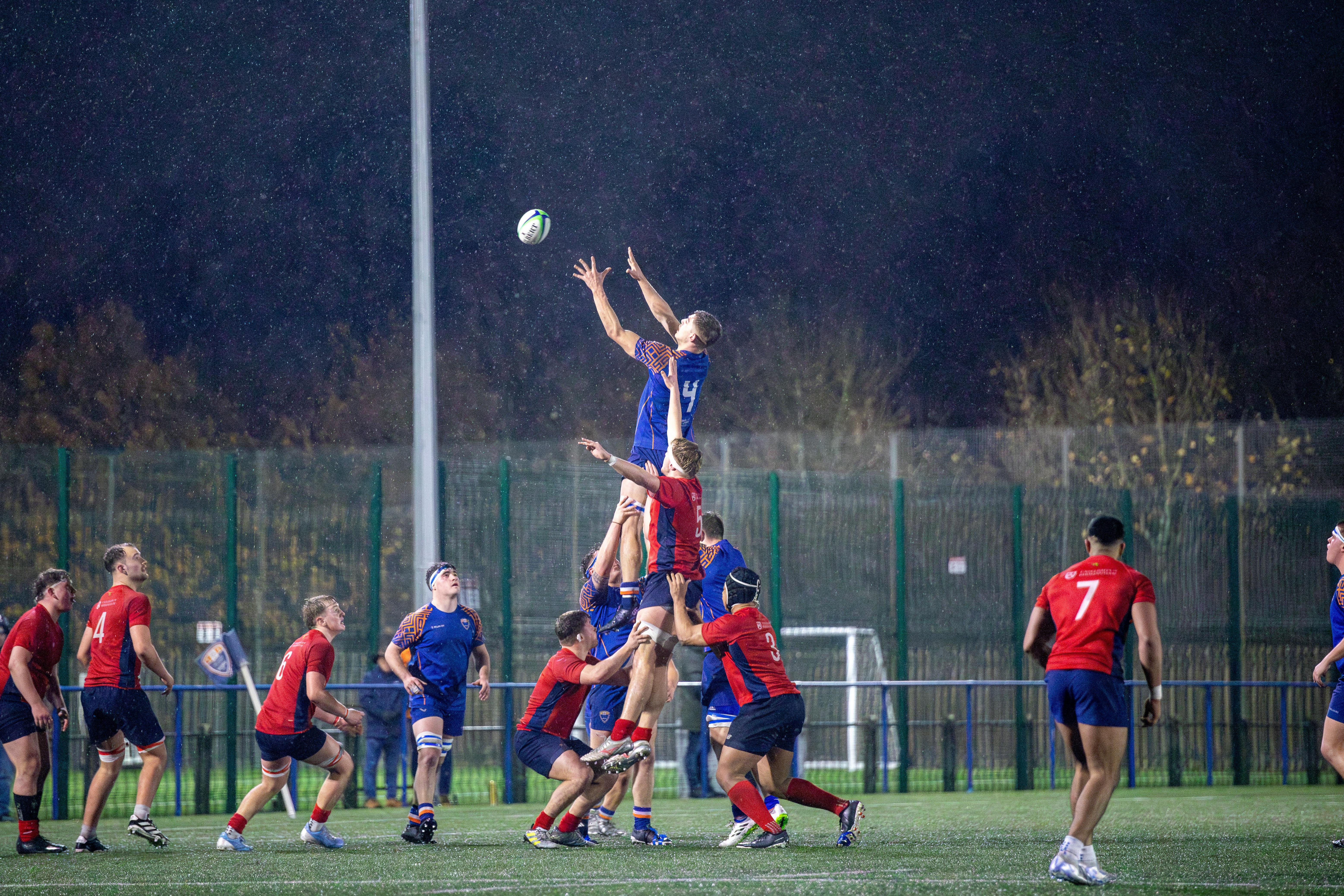 Intense Rugby Match in Action on Rainy Night · Free Stock Photo