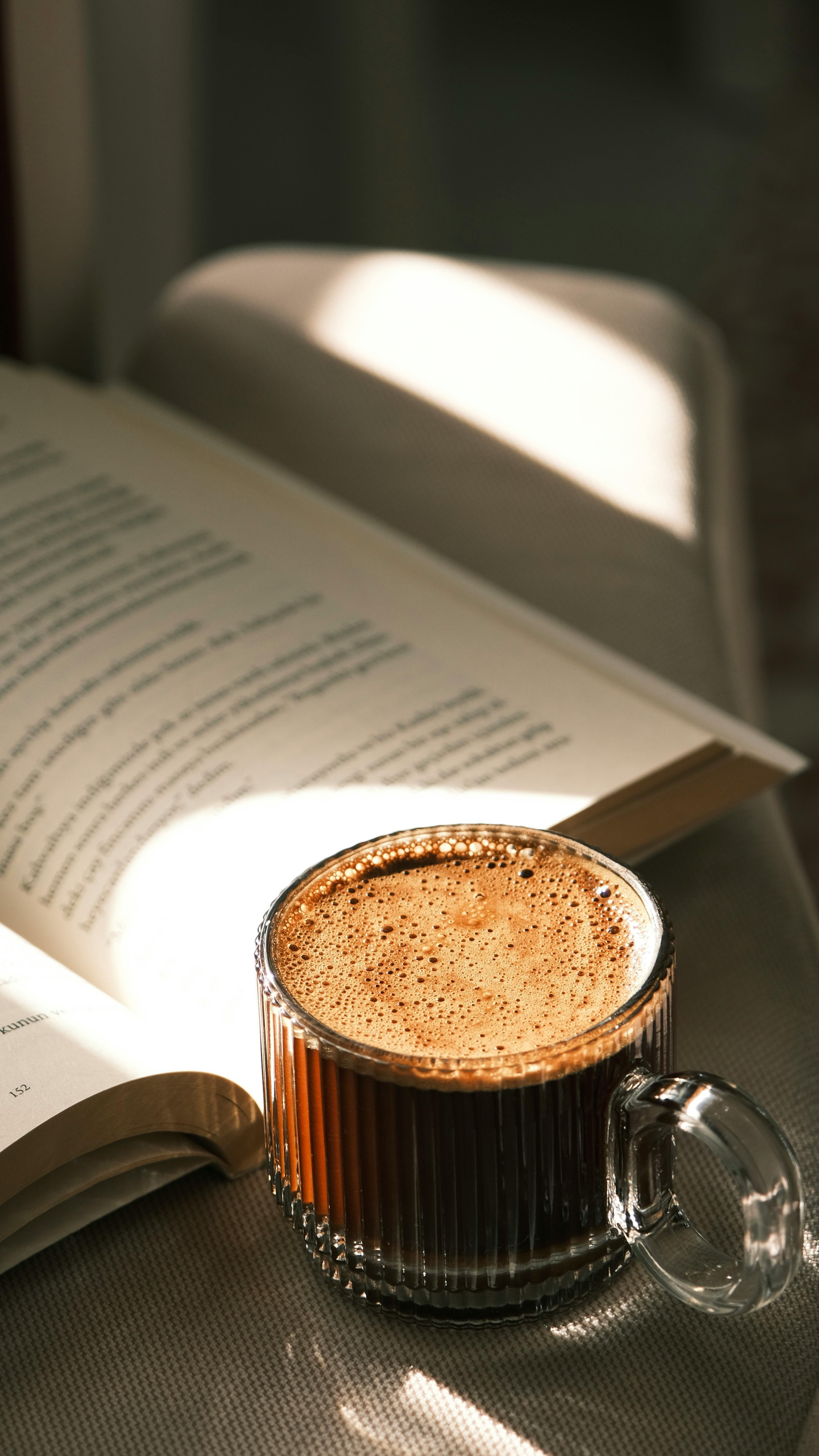Cozy Morning Reading with Coffee in Sunlight · Free Stock Photo