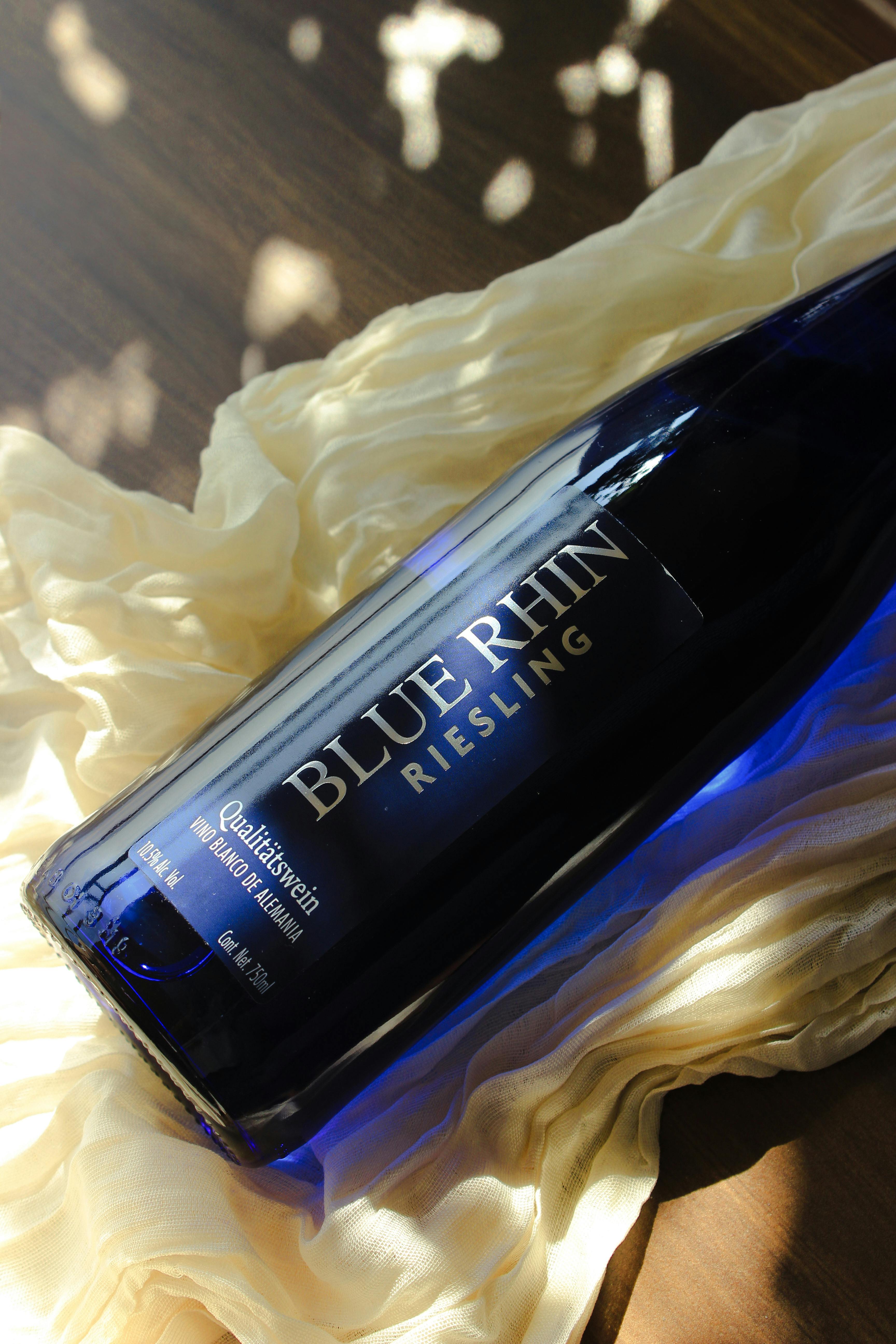 Elegant Blue Rhin Riesling Wine Bottle Display · Free Stock Photo