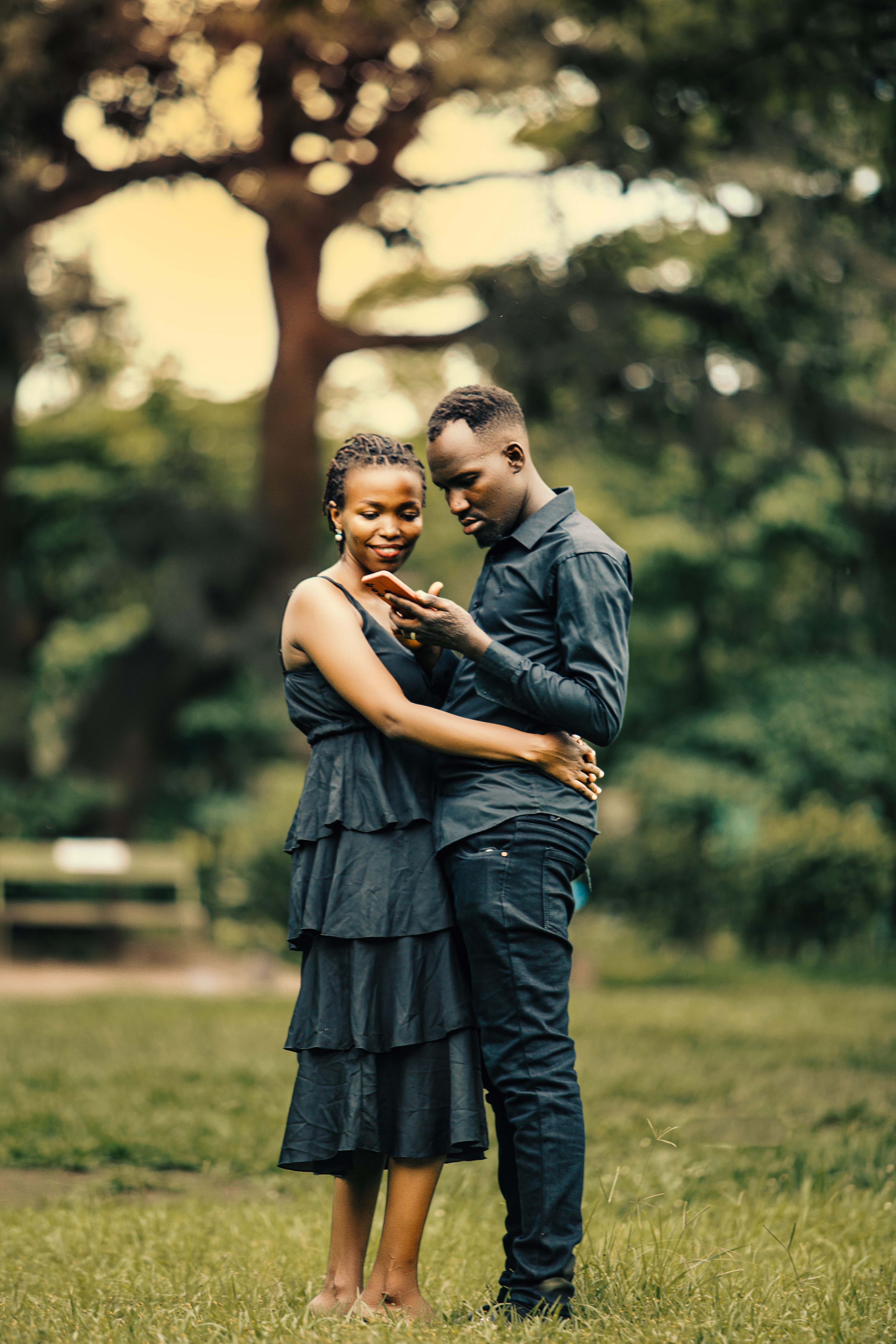 Romantic Couple Embracing in Park Setting · Free Stock Photo