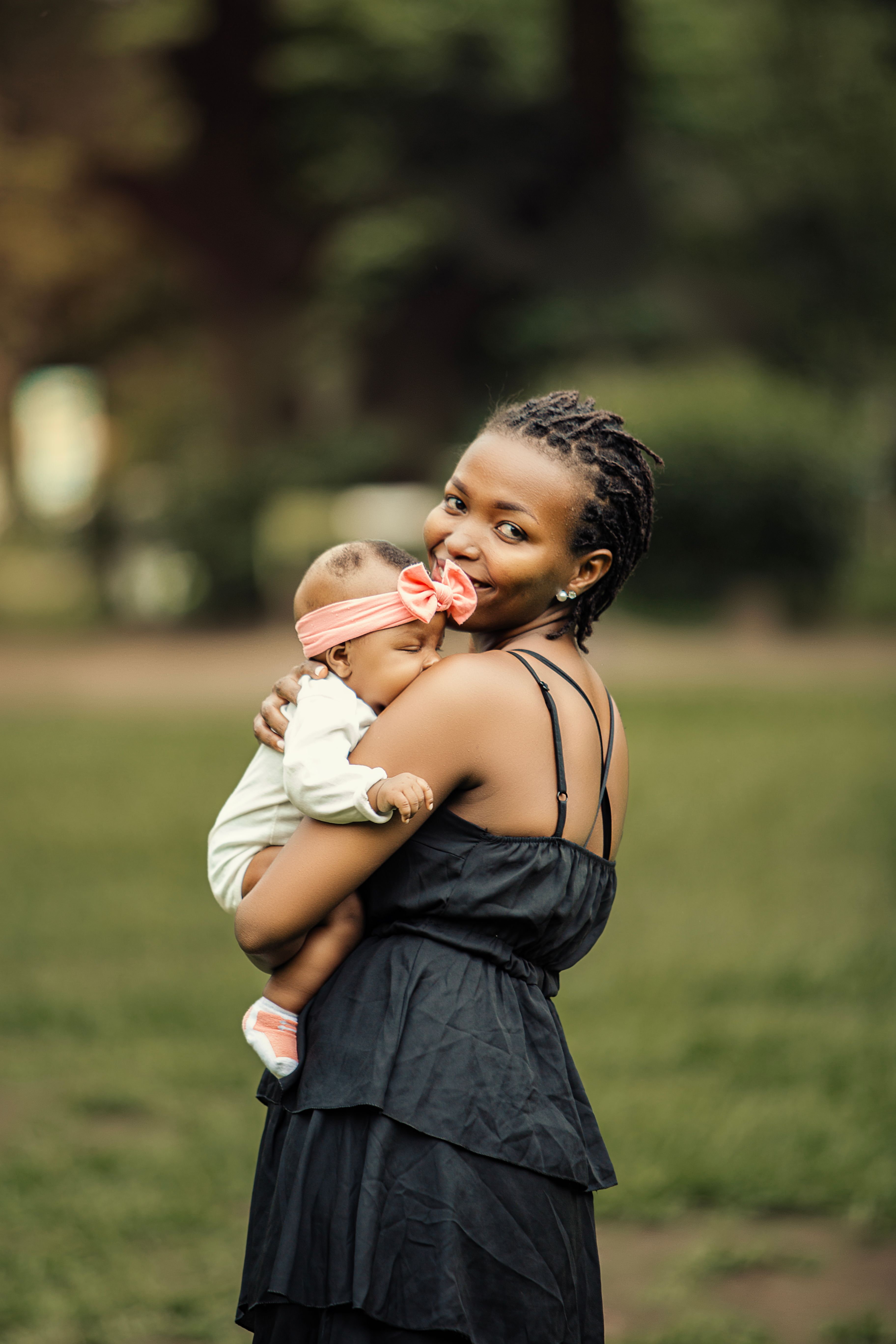 Mother Embracing Baby in Outdoor Setting · Free Stock Photo