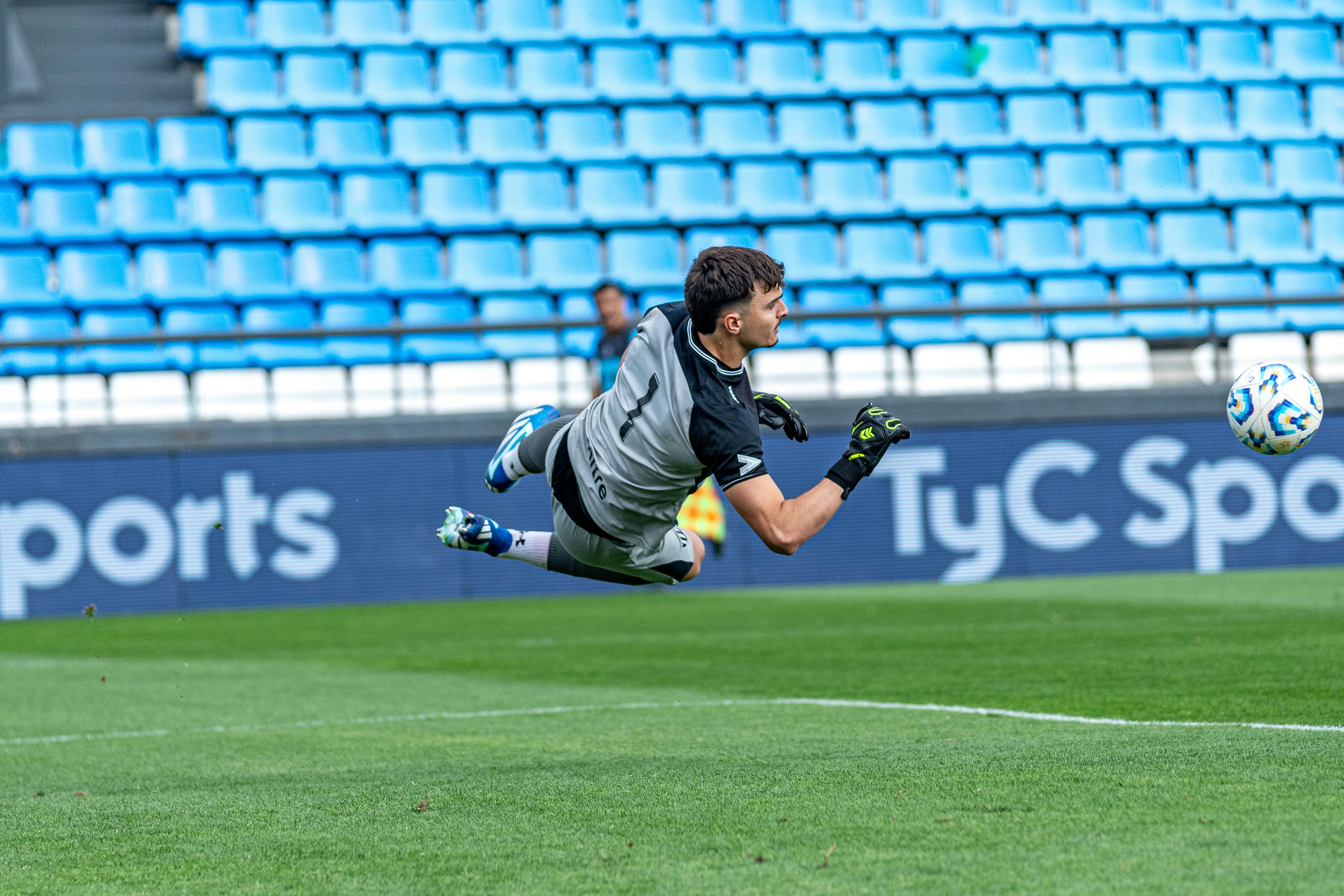 Goalkeeper Diving for Soccer Ball in Action Shot · Free Stock Photo