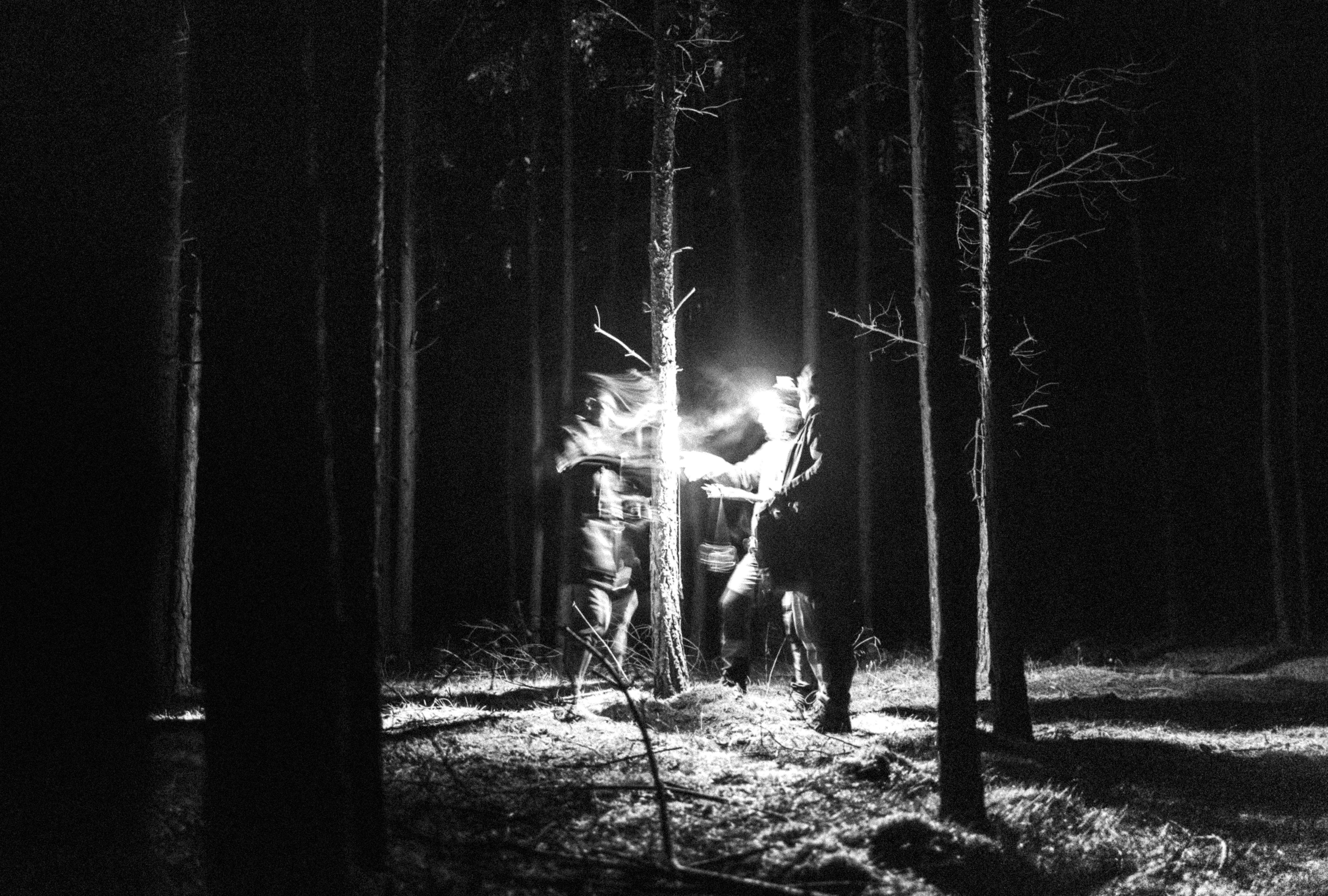 Long Exposure in Night Forest with Ghostly Figures · Free Stock Photo