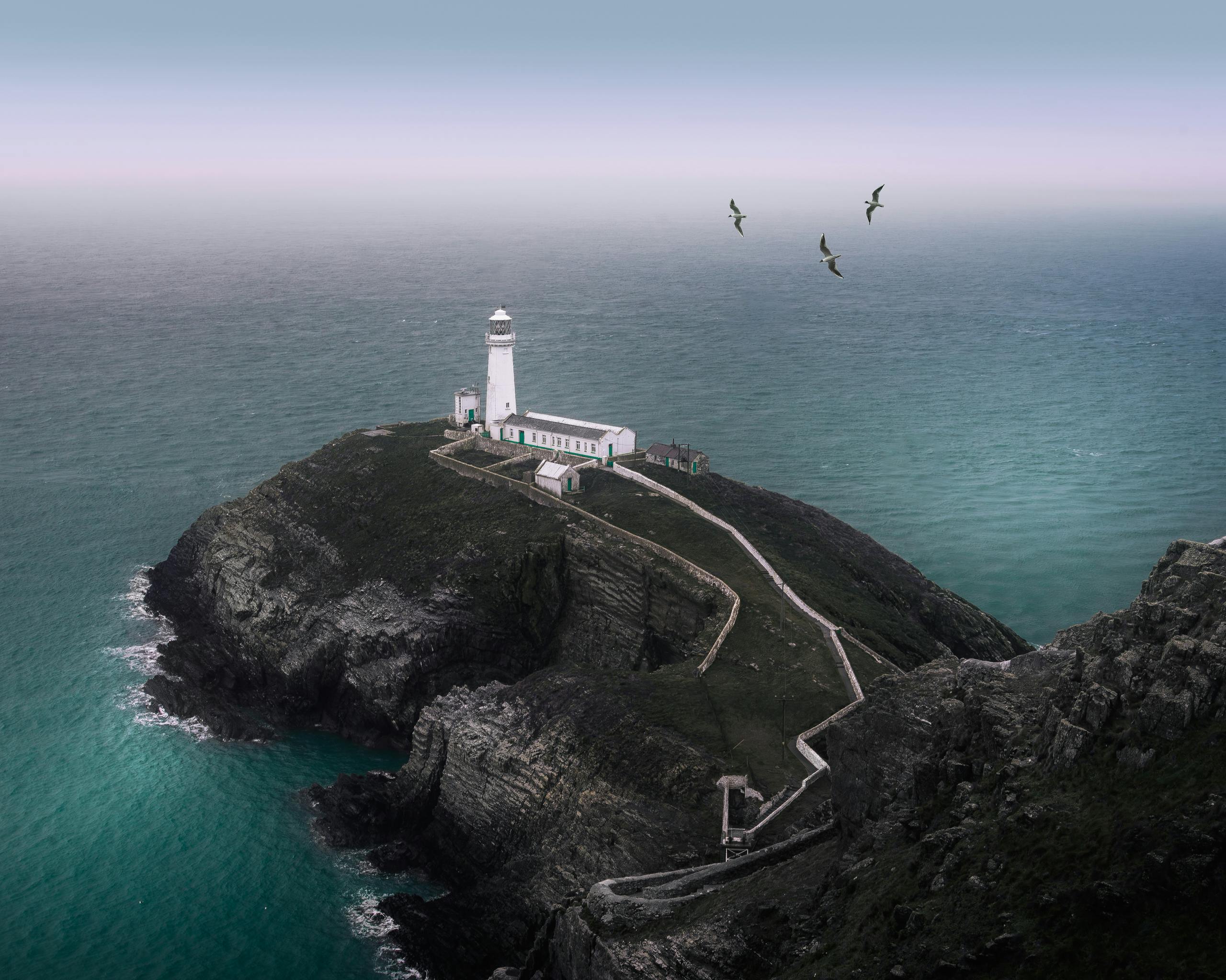 Stunning Aerial View of Lighthouse on Cliffside · Free Stock Photo