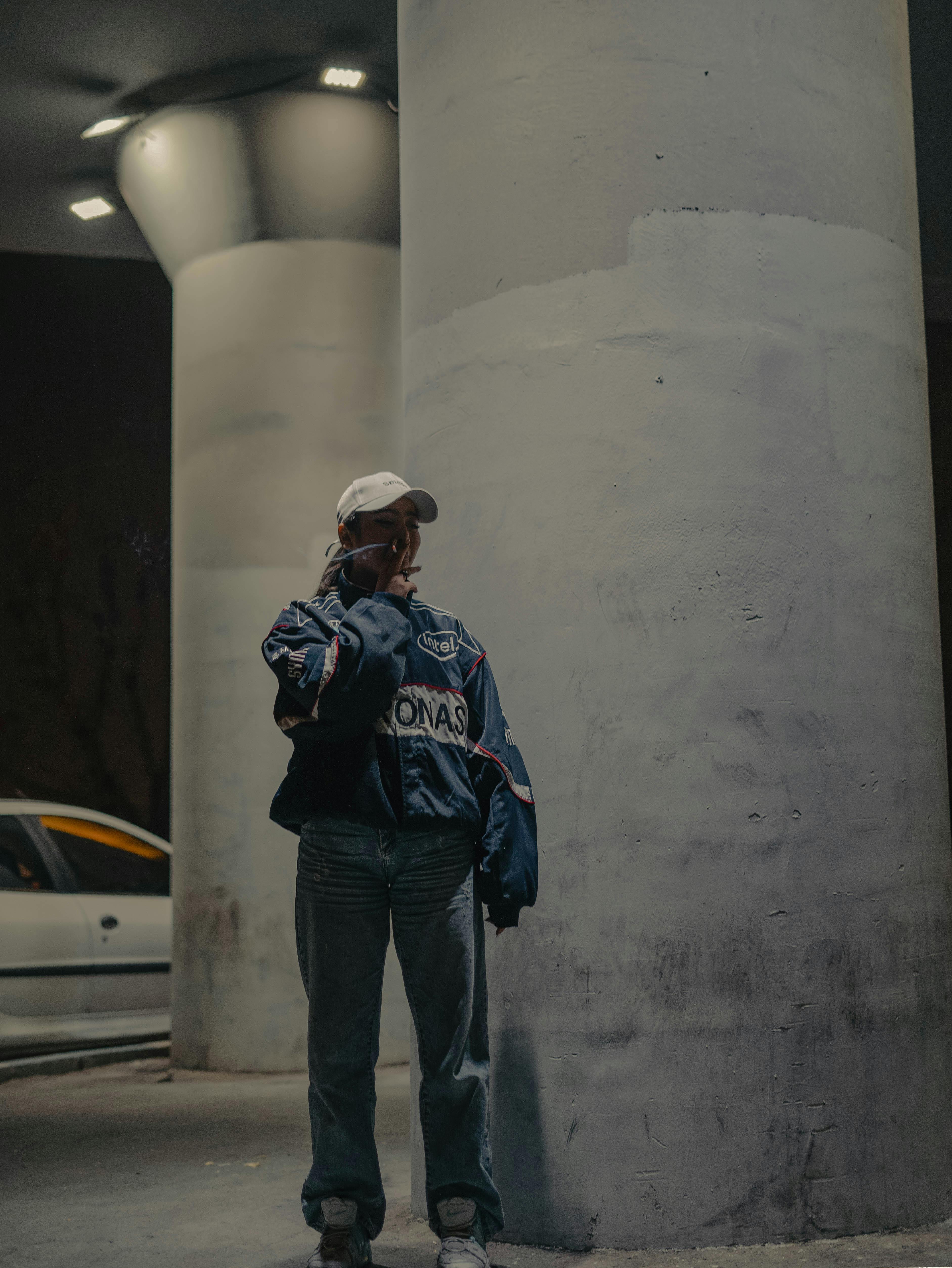 Youthful Individual Under Streetlights in Urban Setting · Free Stock Photo