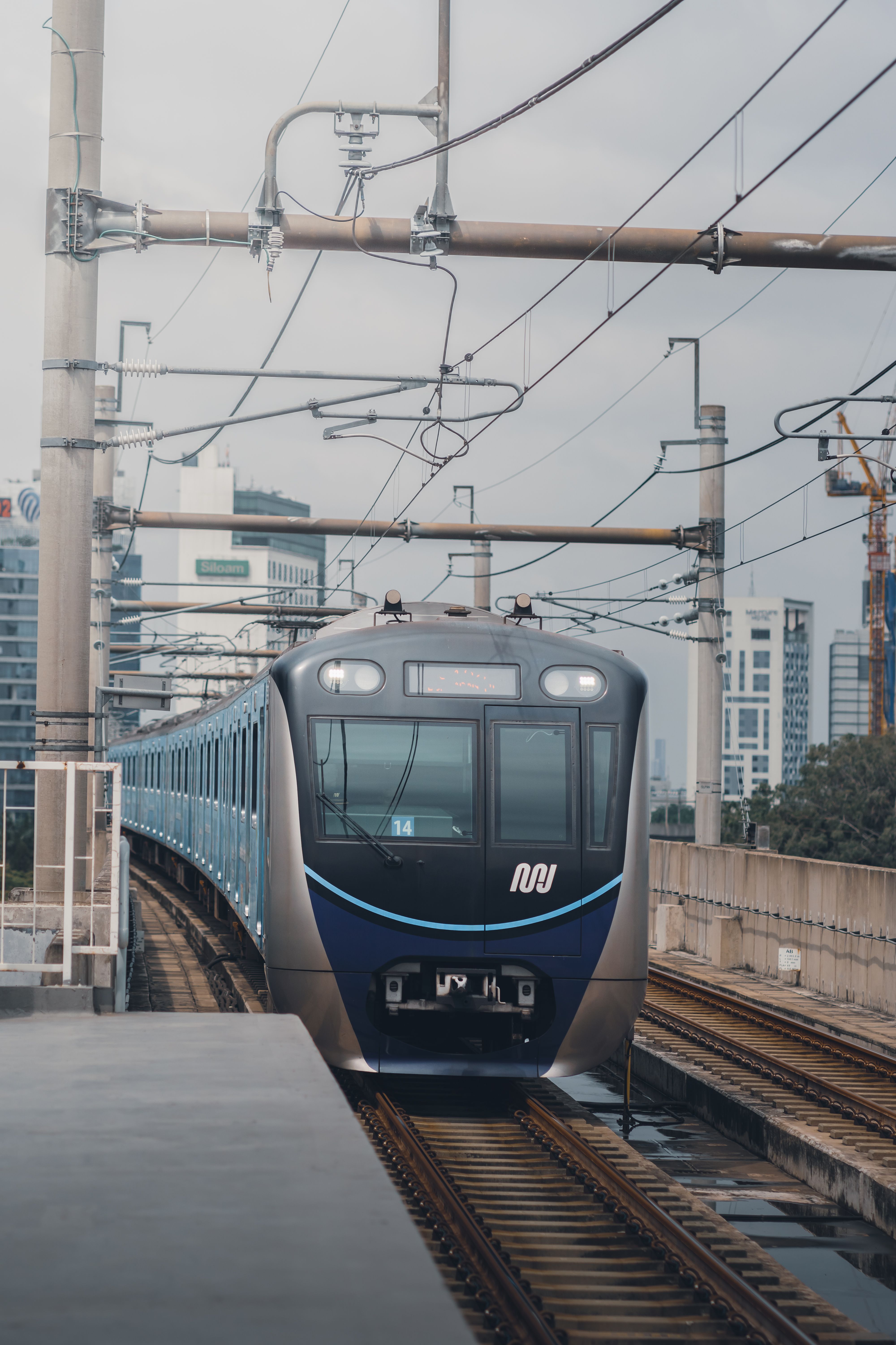Modern Electric Train in Jakarta Urban Setting · Free Stock Photo