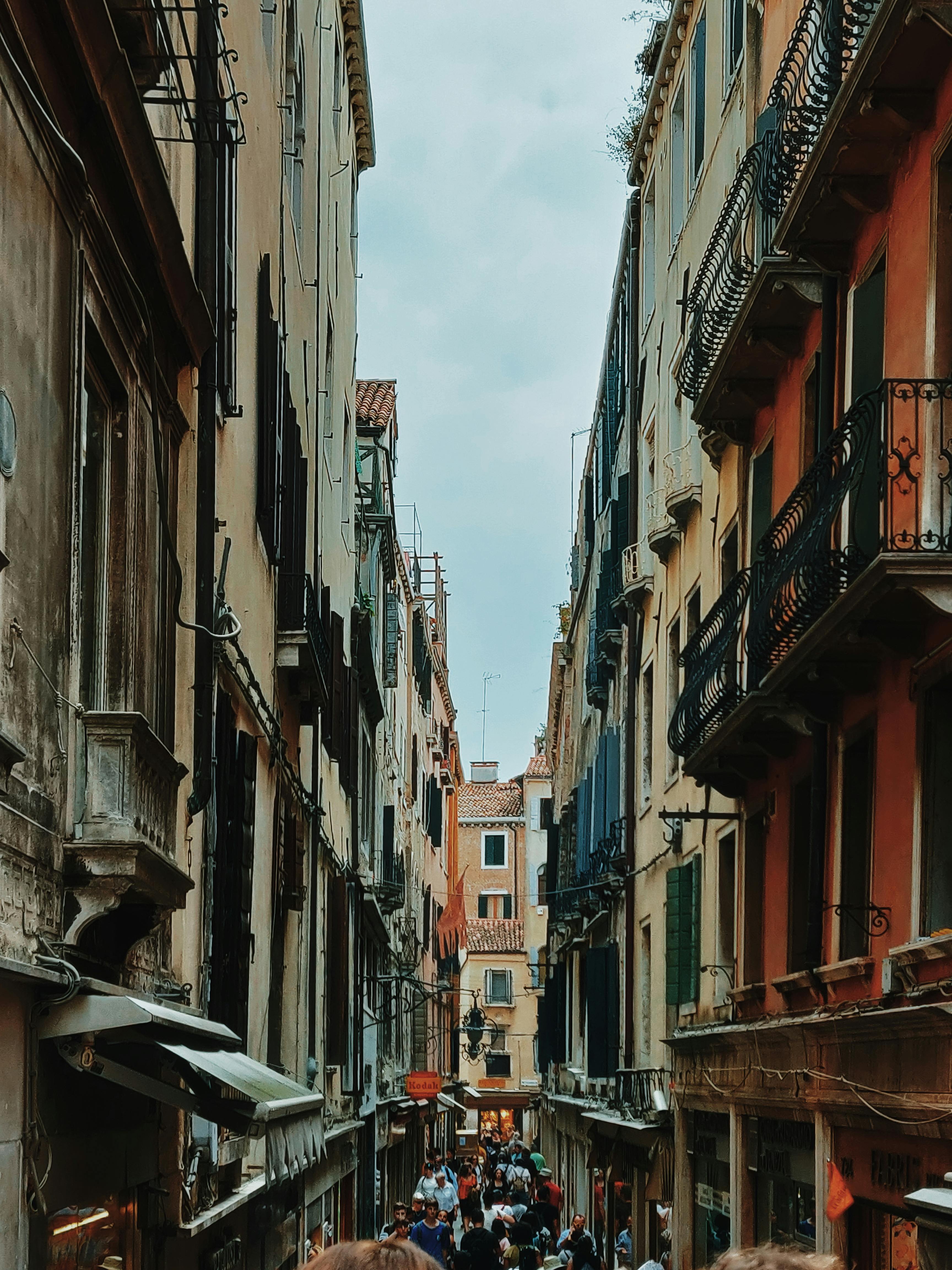 People Between Buildings · Free Stock Photo