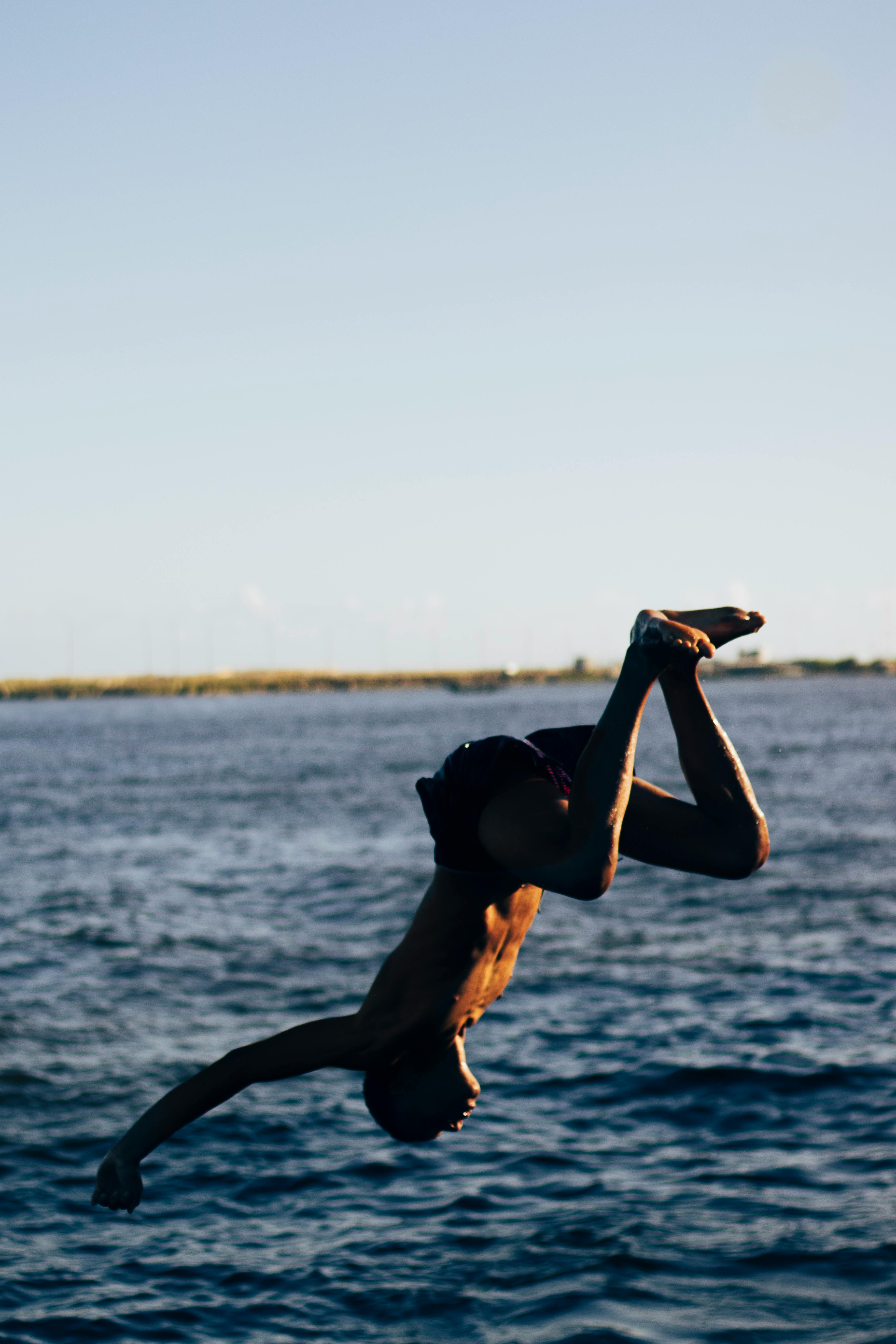 Young Man Performing Dive into Ocean · Free Stock Photo