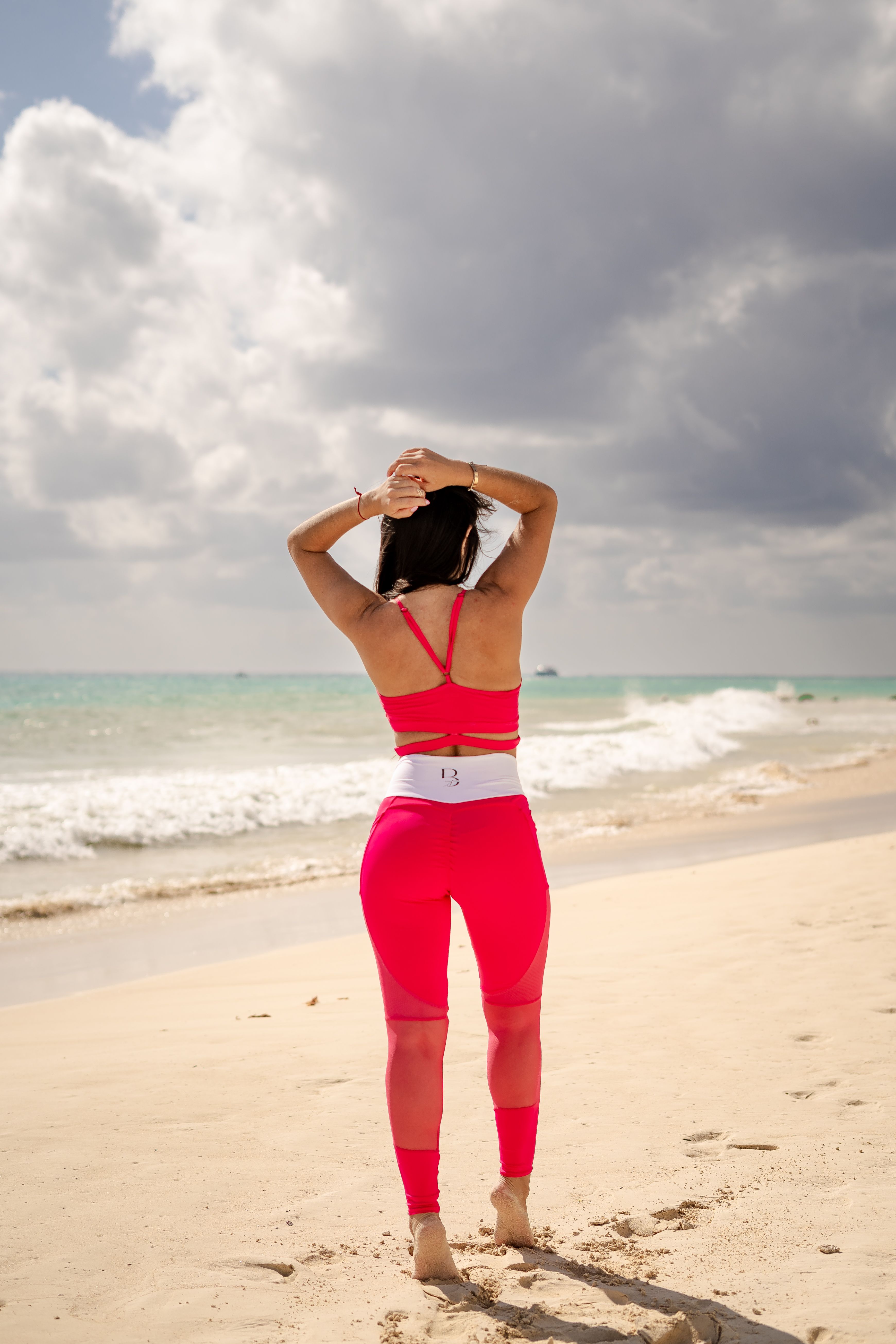Woman in Bright Pink Activewear on Beach Scene · Free Stock Photo