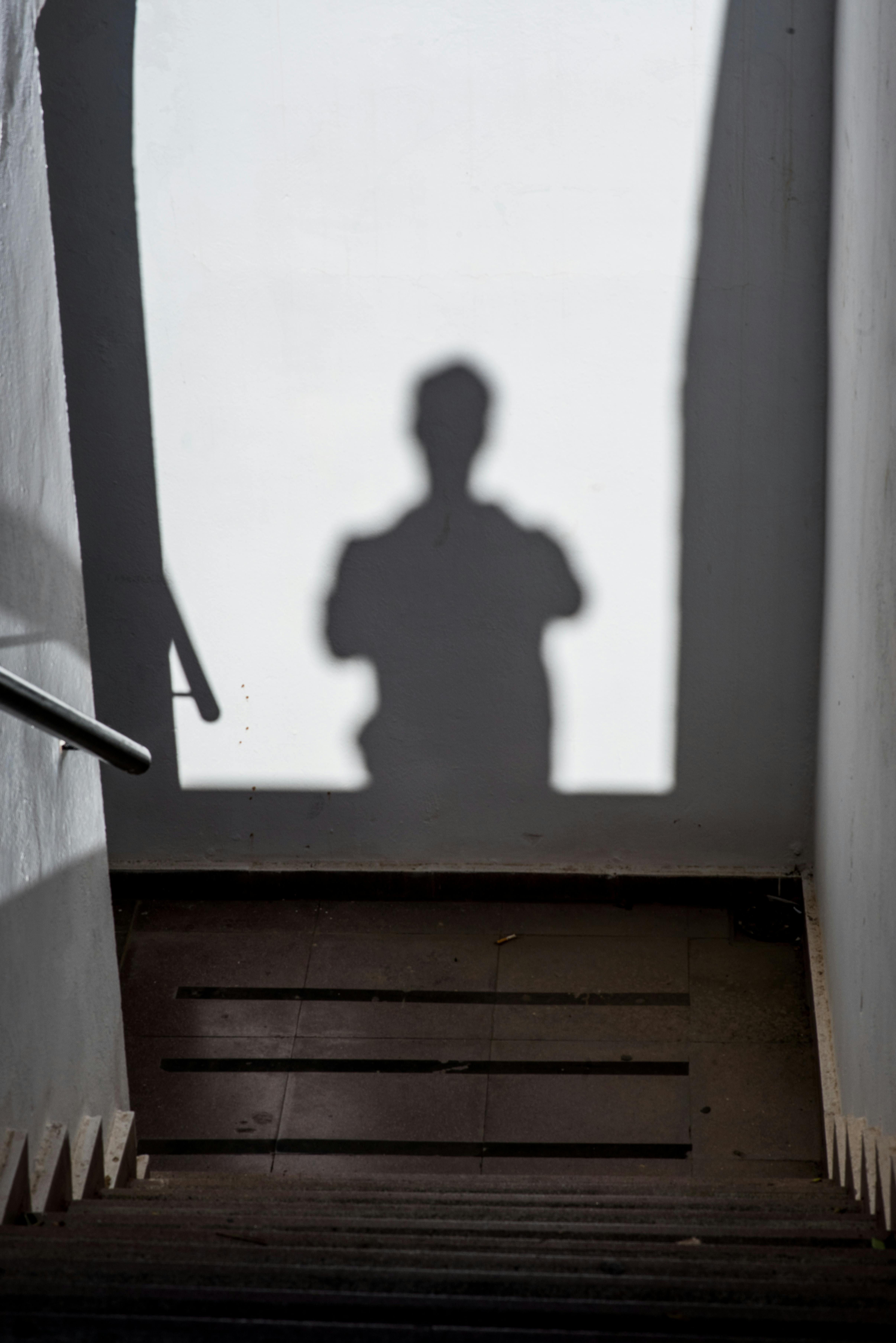 Mysterious Shadow Against Concrete Wall · Free Stock Photo