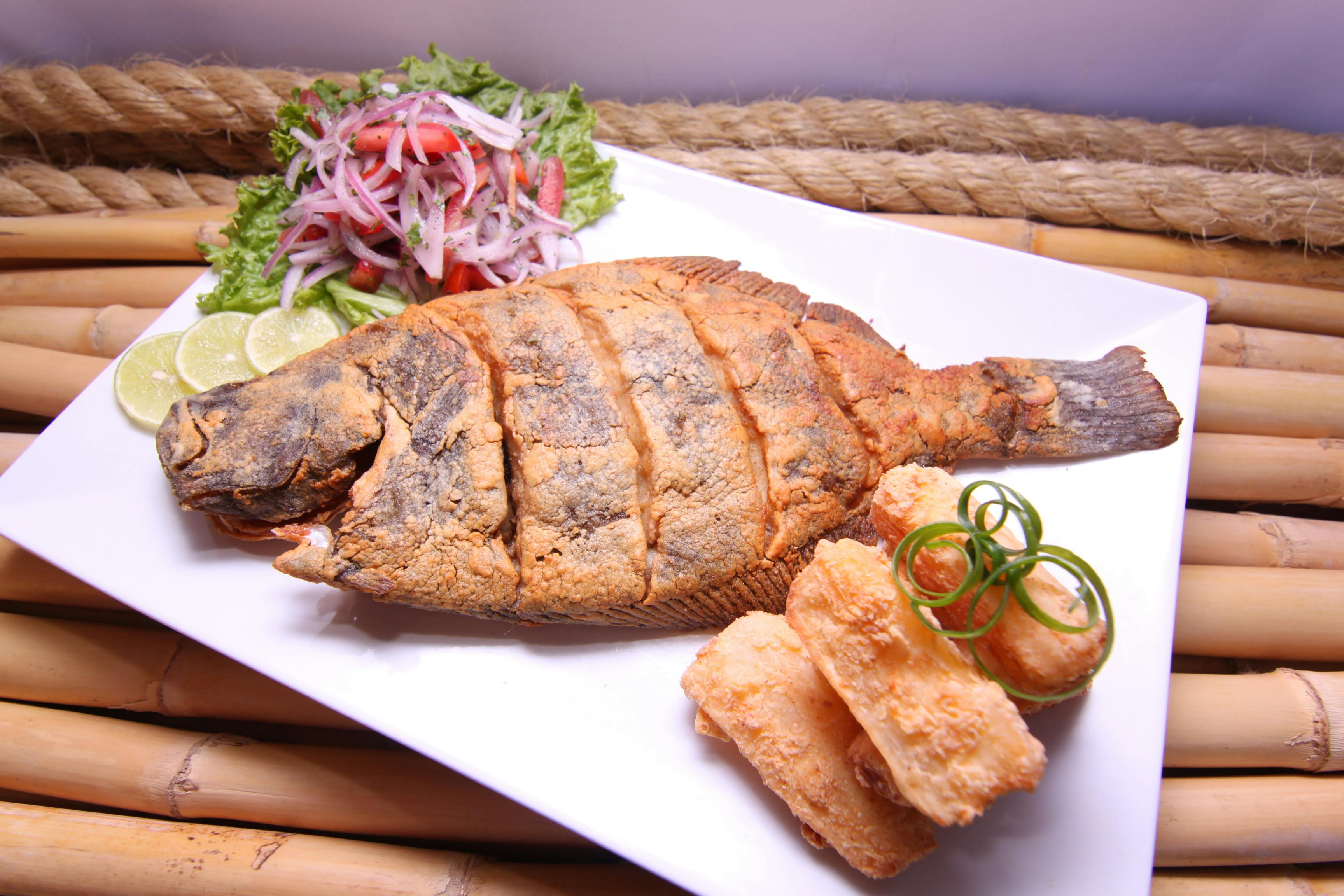 Delicious Peruvian Fried Fish Dish on Plate · Free Stock Photo