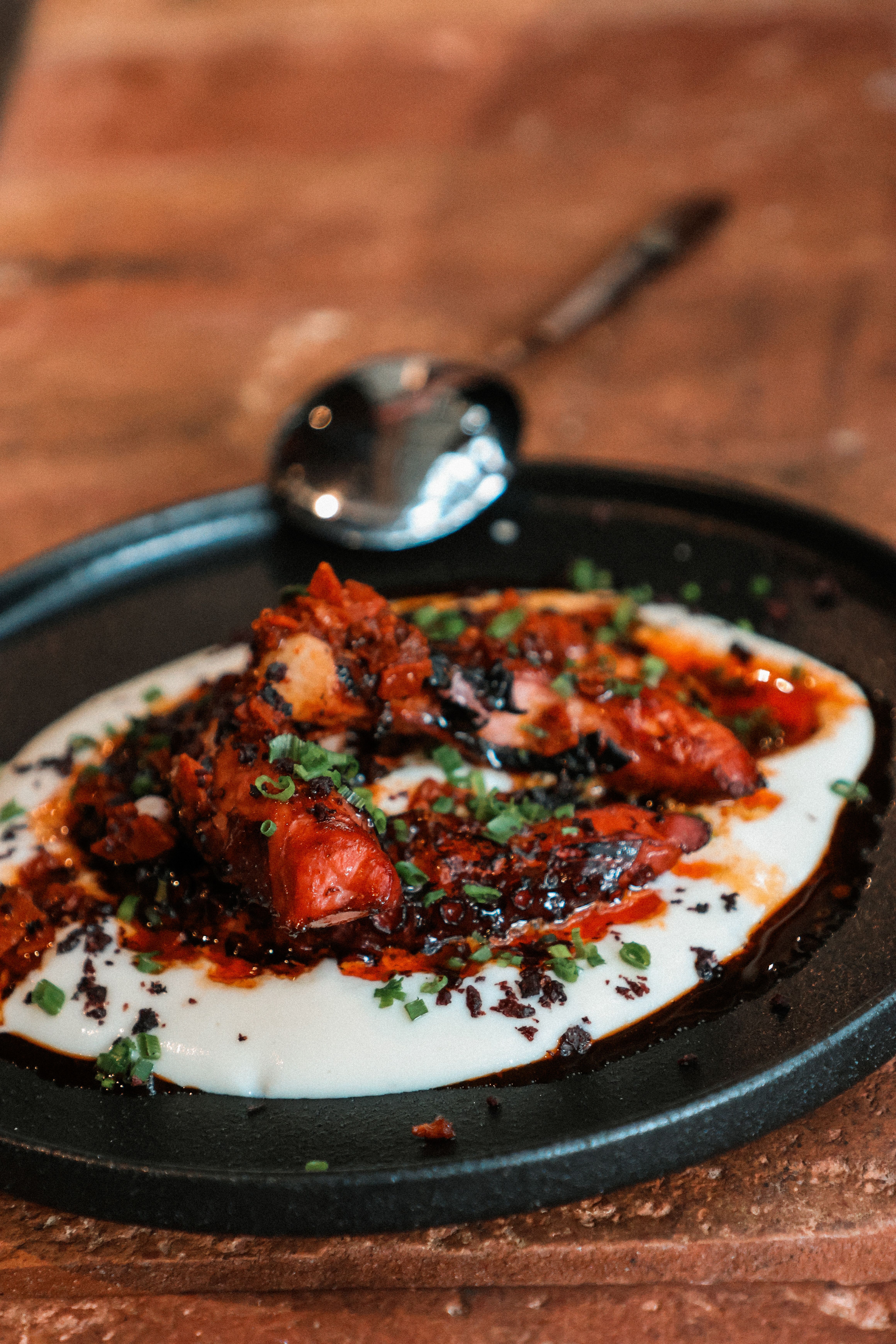 Rustic Octopus Dish on Wooden Table · Free Stock Photo