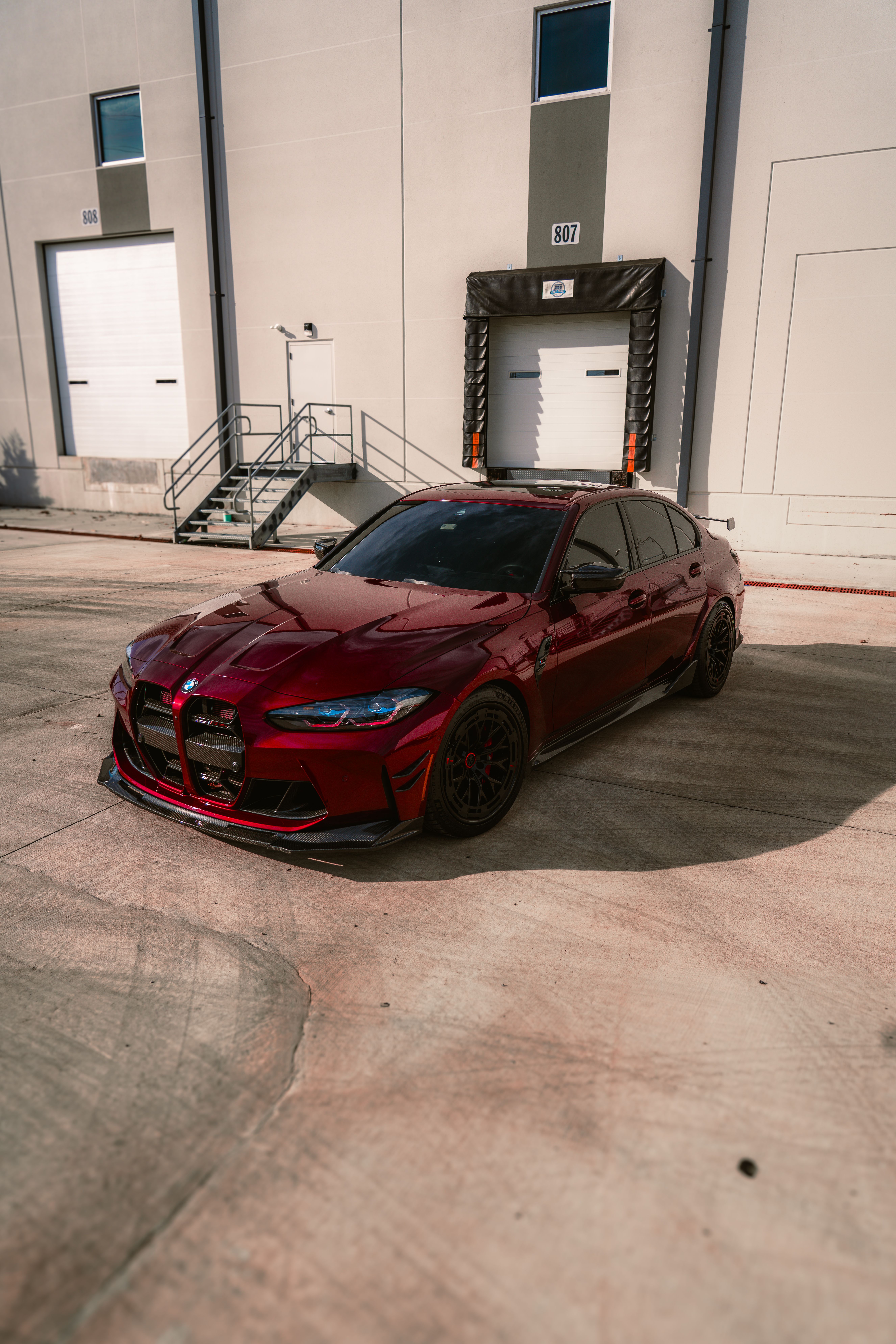 Sleek Red BMW M3 in Industrial Setting · Free Stock Photo