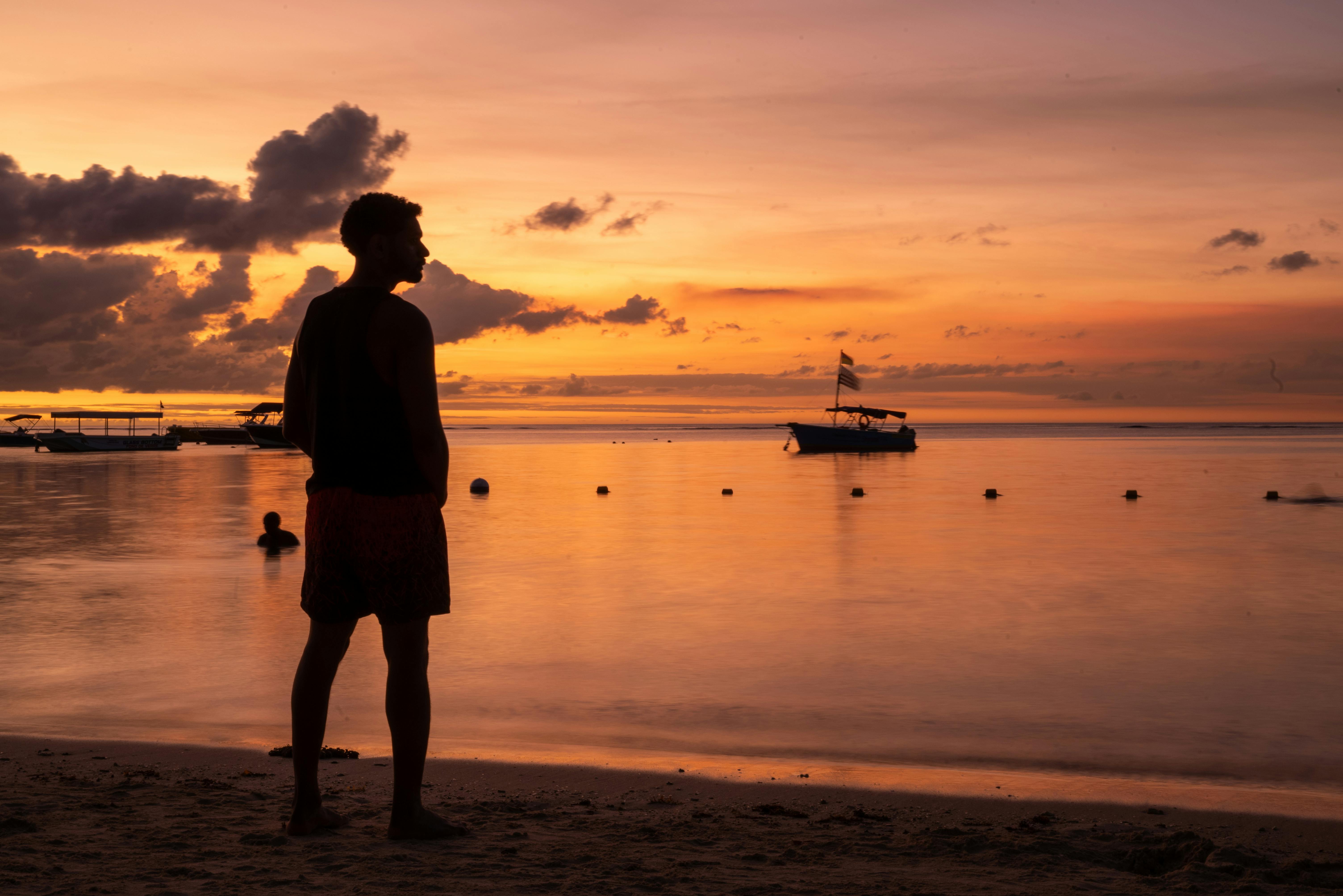 Silhouette of a Man on Beach at Sunset · Free Stock Photo