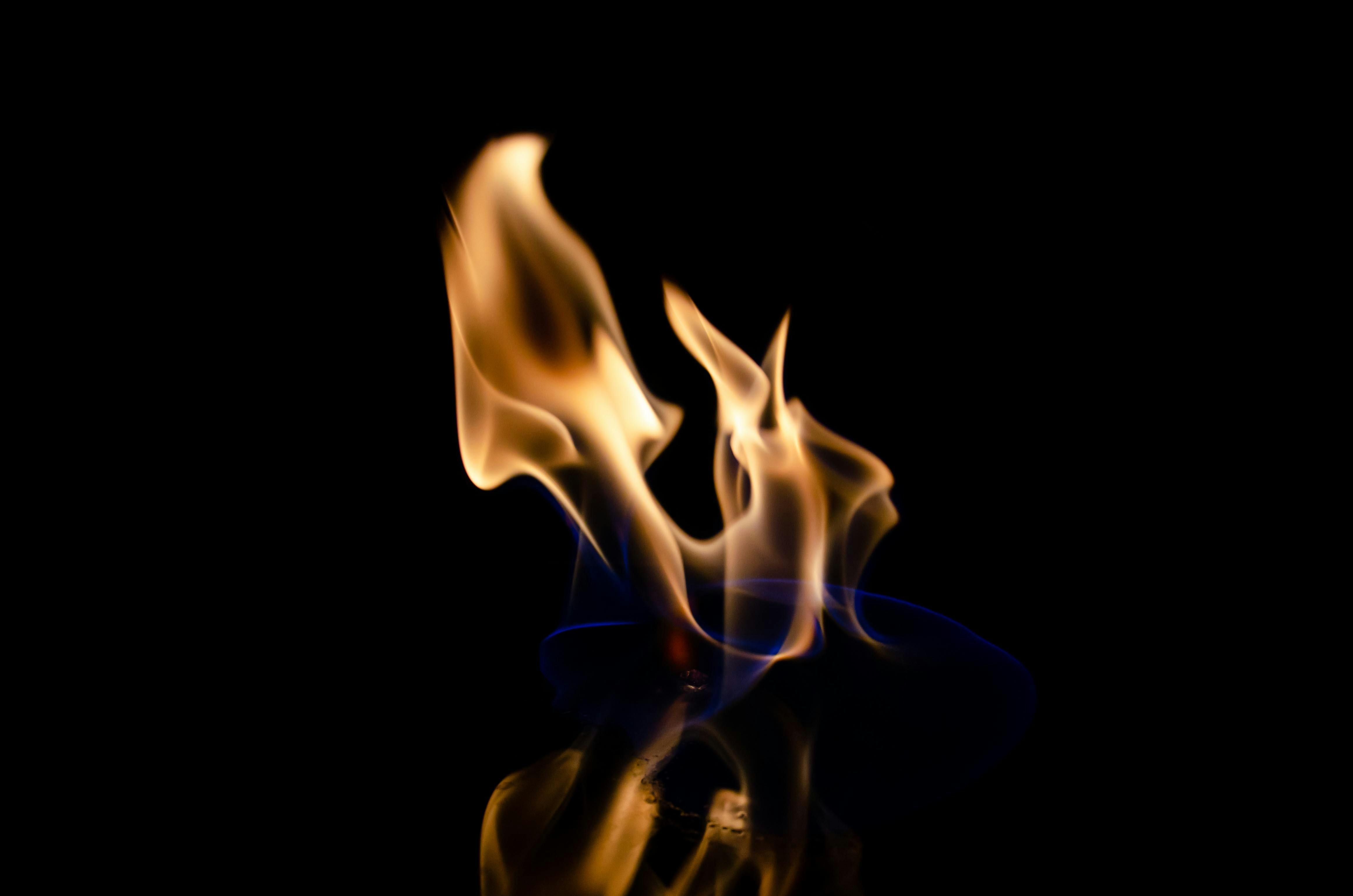 Artistic Flames on a Reflective Surface in Low Light · Free Stock Photo