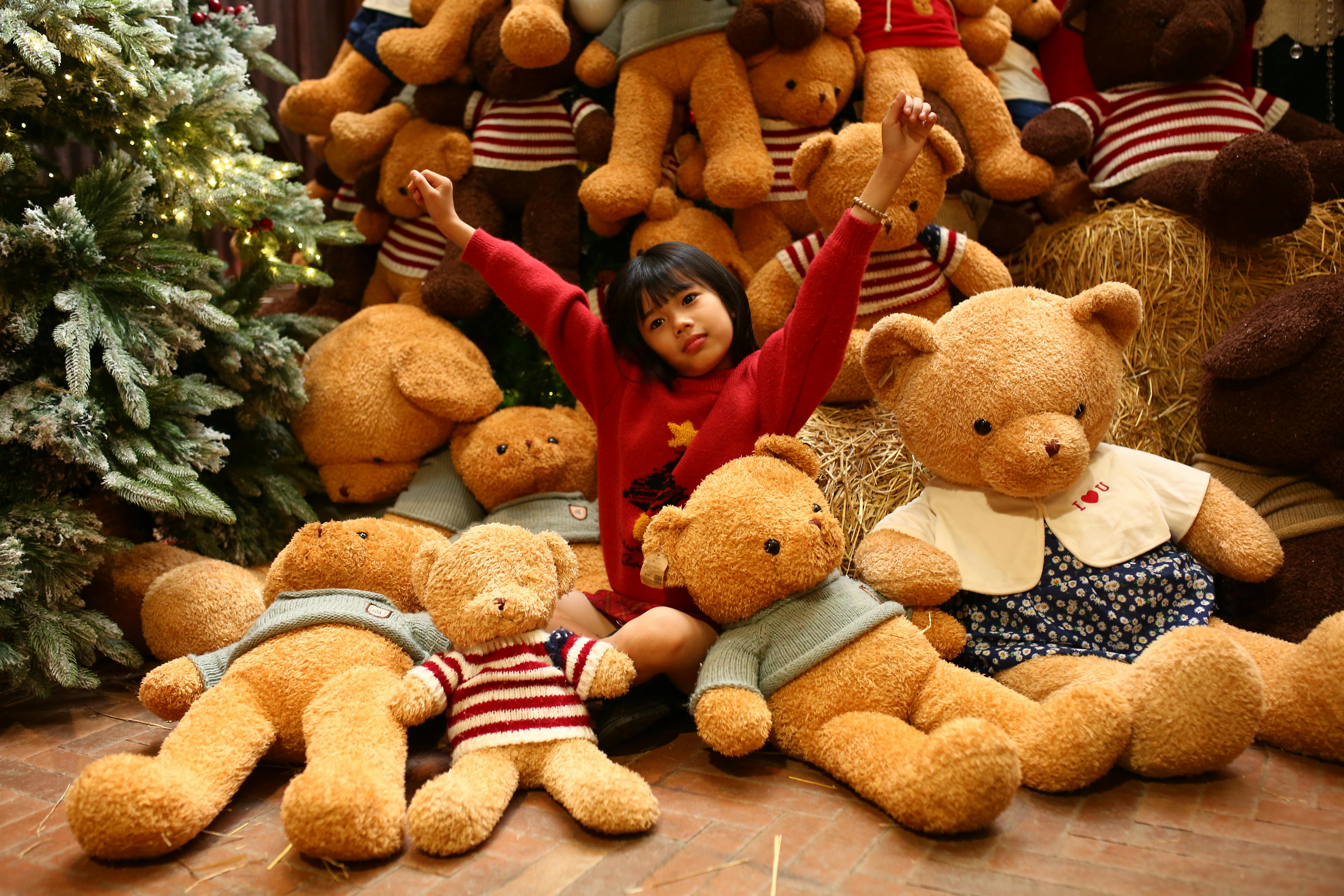 Child with Teddy Bears in Festive Setting · Free Stock Photo