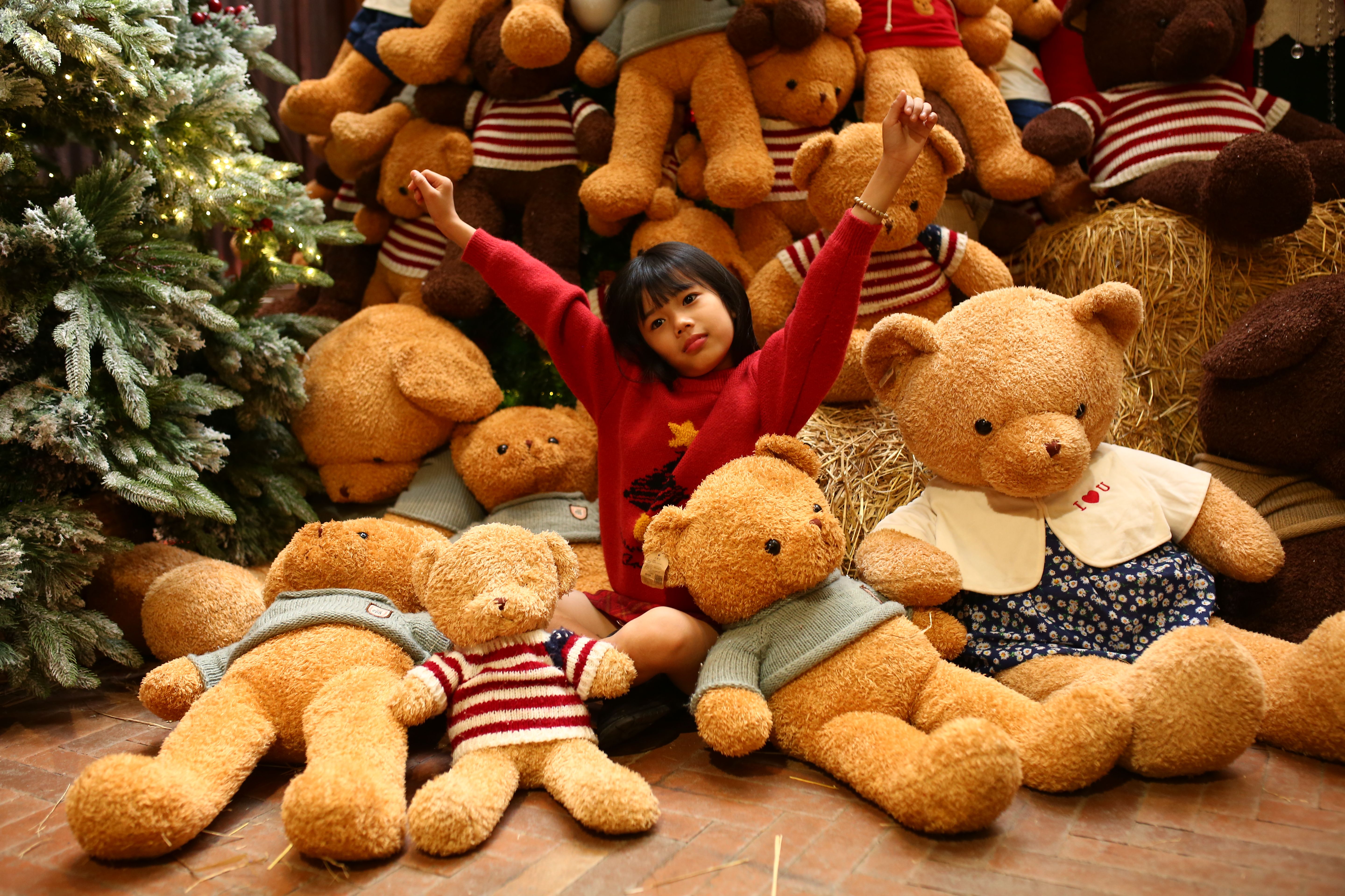 Child with Teddy Bears in Festive Setting · Free Stock Photo