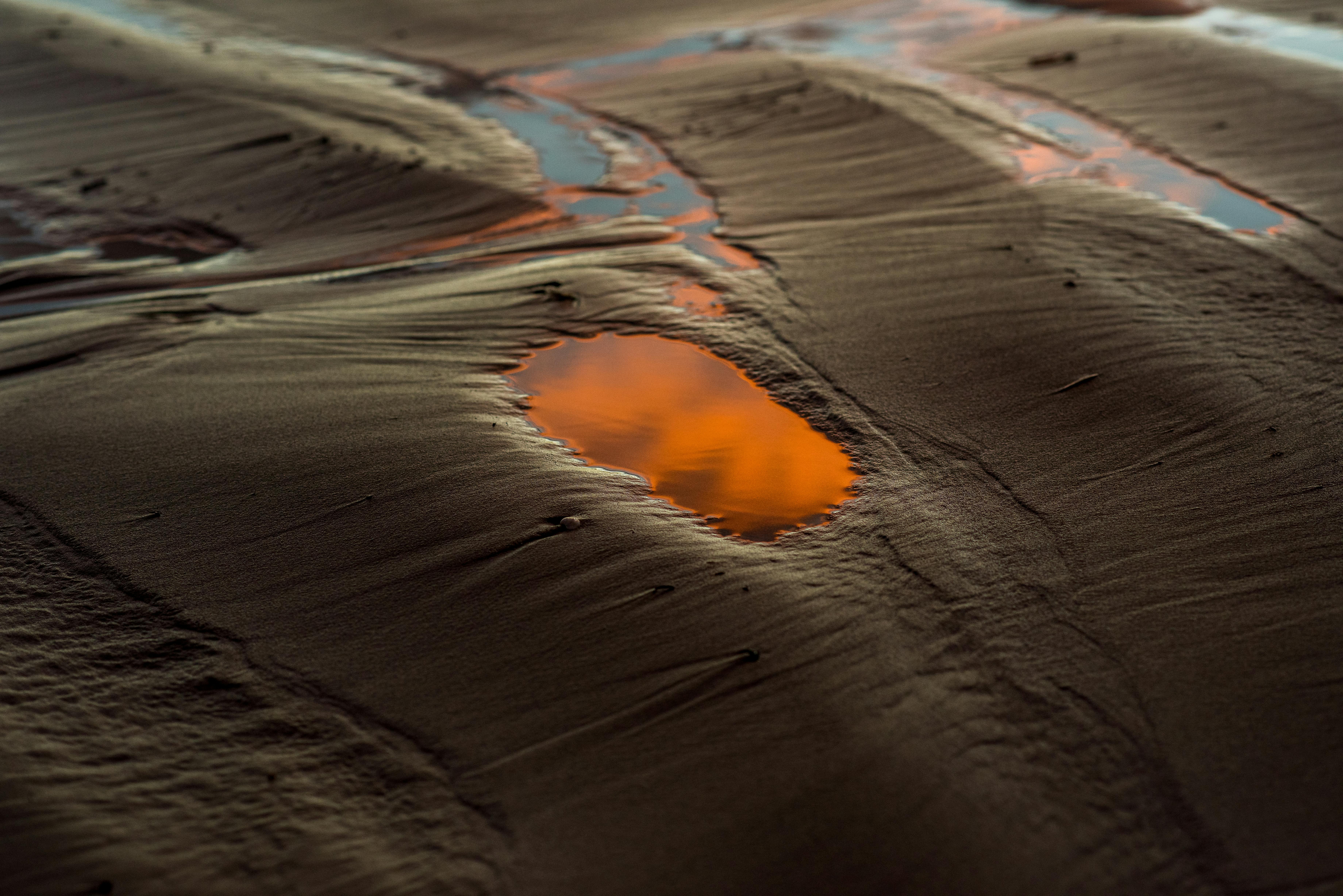 Reflective Sunrise on Sandy Beach Patterns · Free Stock Photo