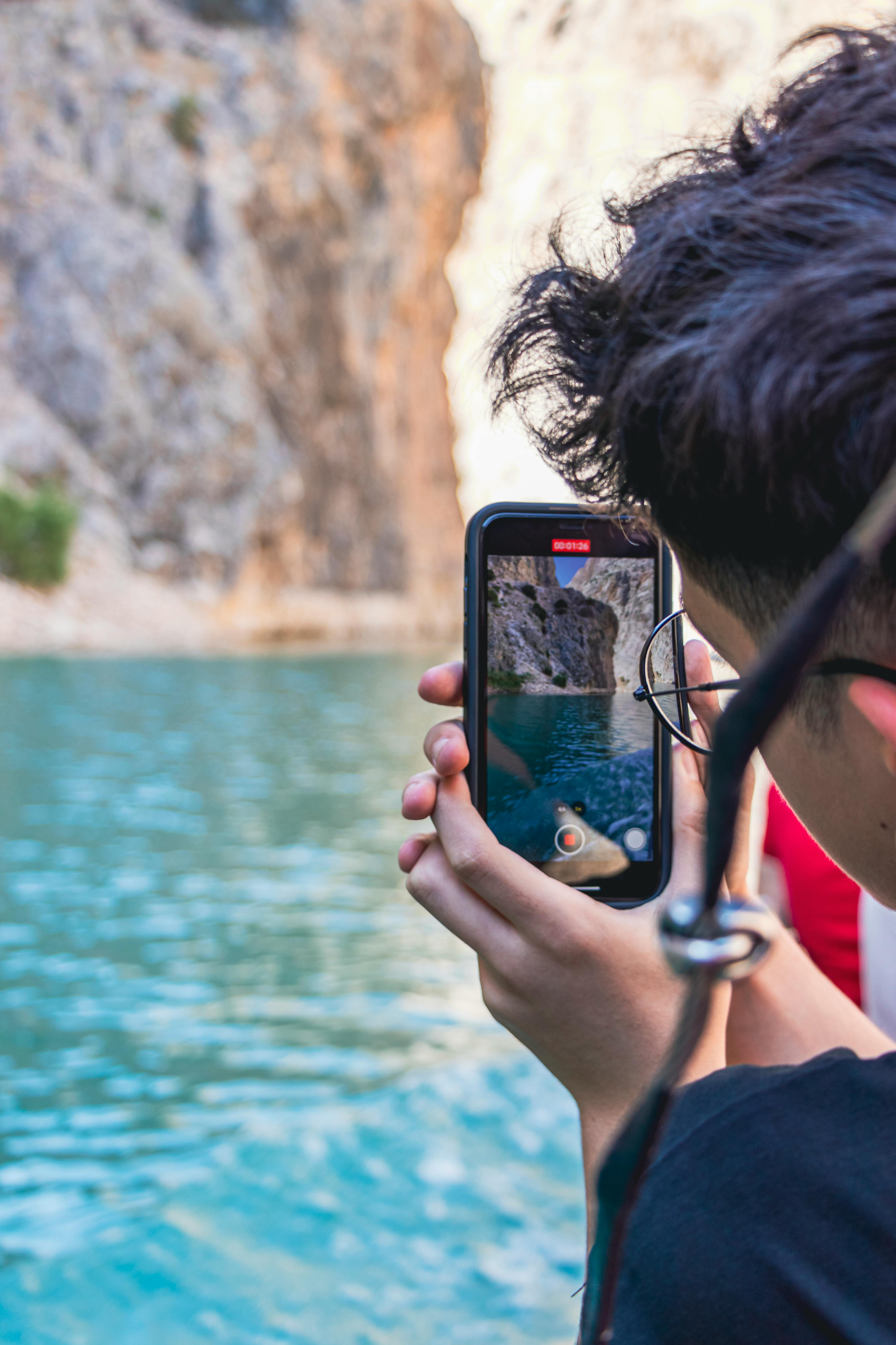 Capturing Scenic View by the Water with Smartphone · Free Stock Photo