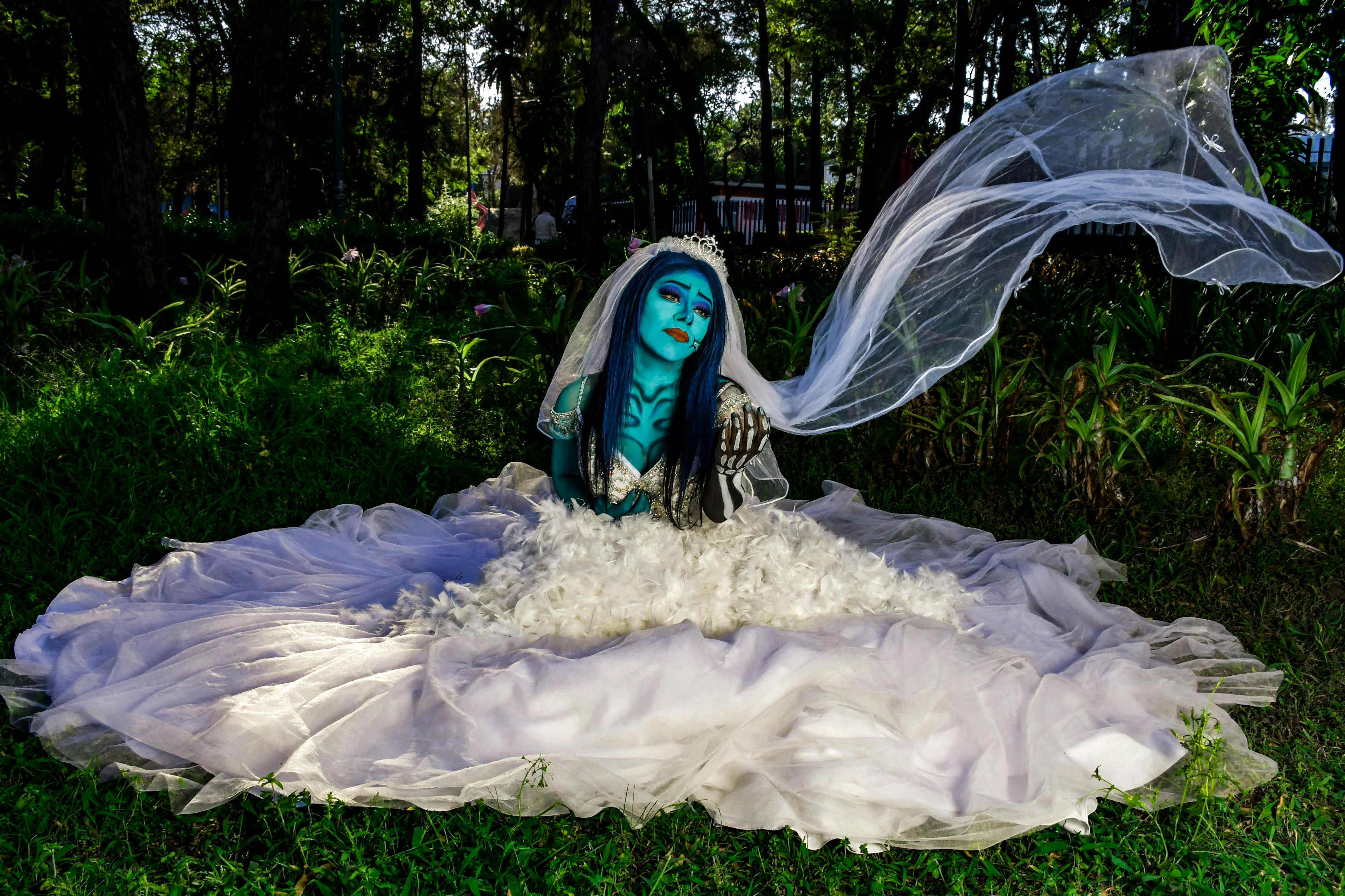 Whimsical Blue Alien Bride Sitting Outdoors · Free Stock Photo