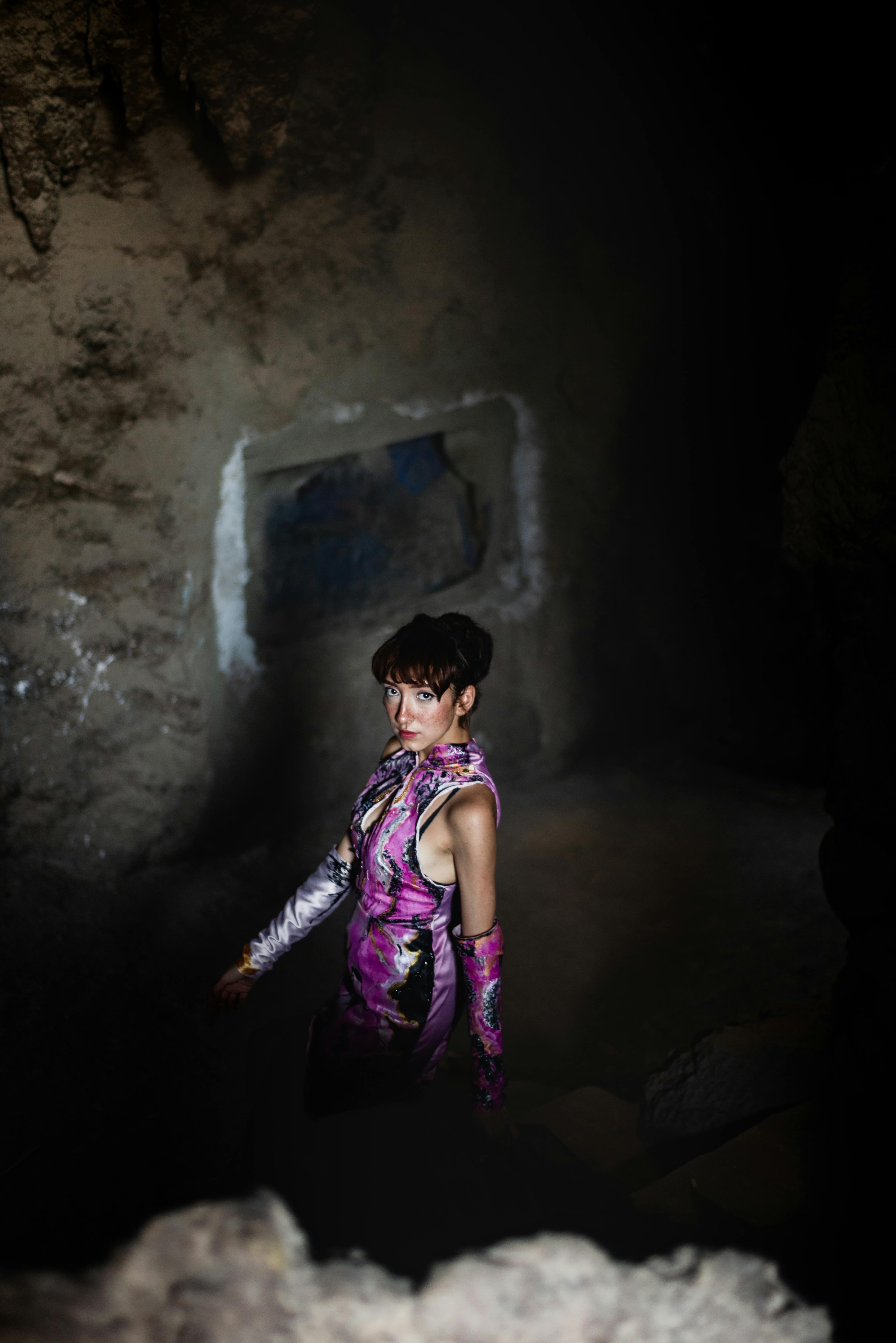 Artistic Portrait of Woman in Dark Cave Setting · Free Stock Photo