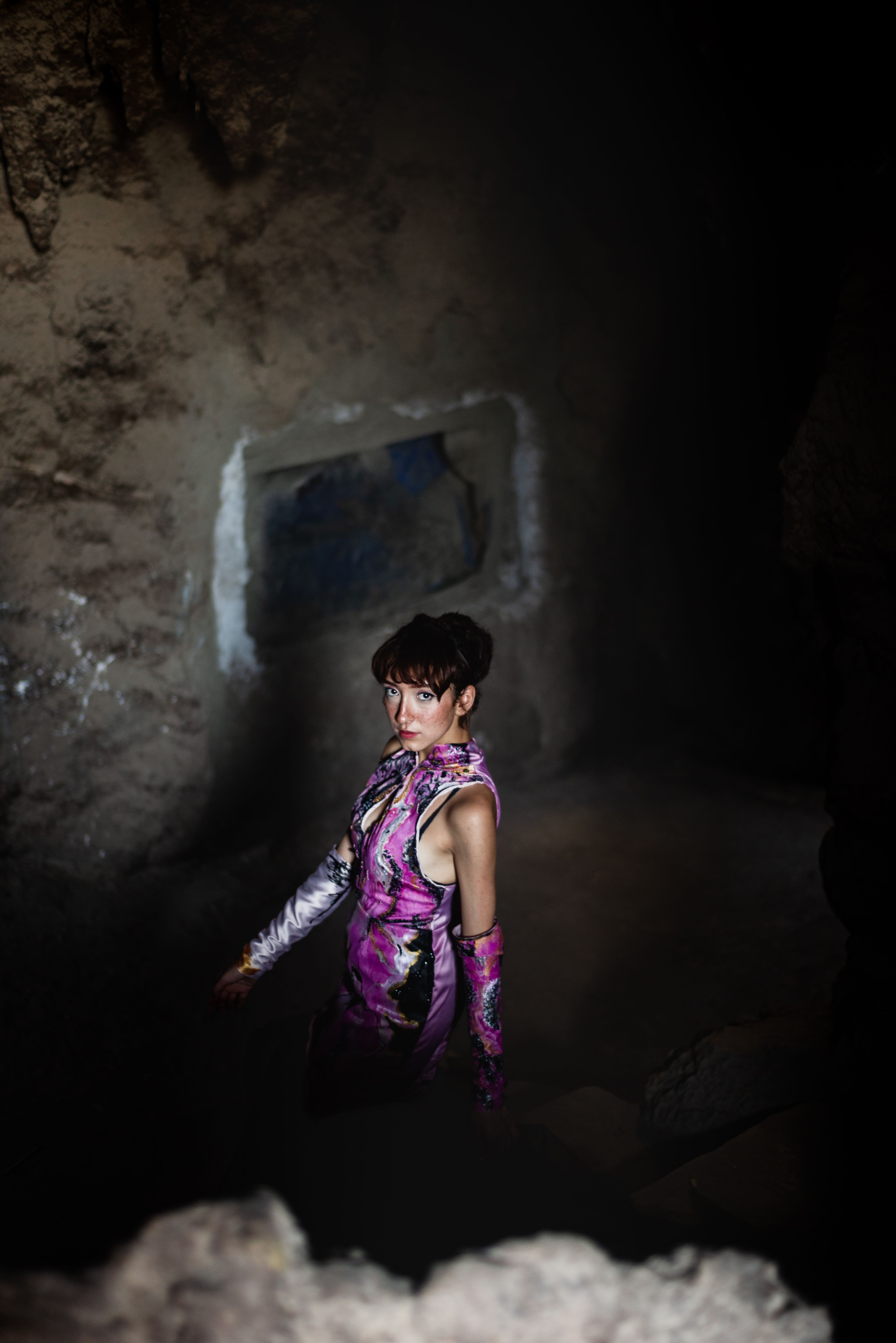 Artistic Portrait of Woman in Dark Cave Setting · Free Stock Photo