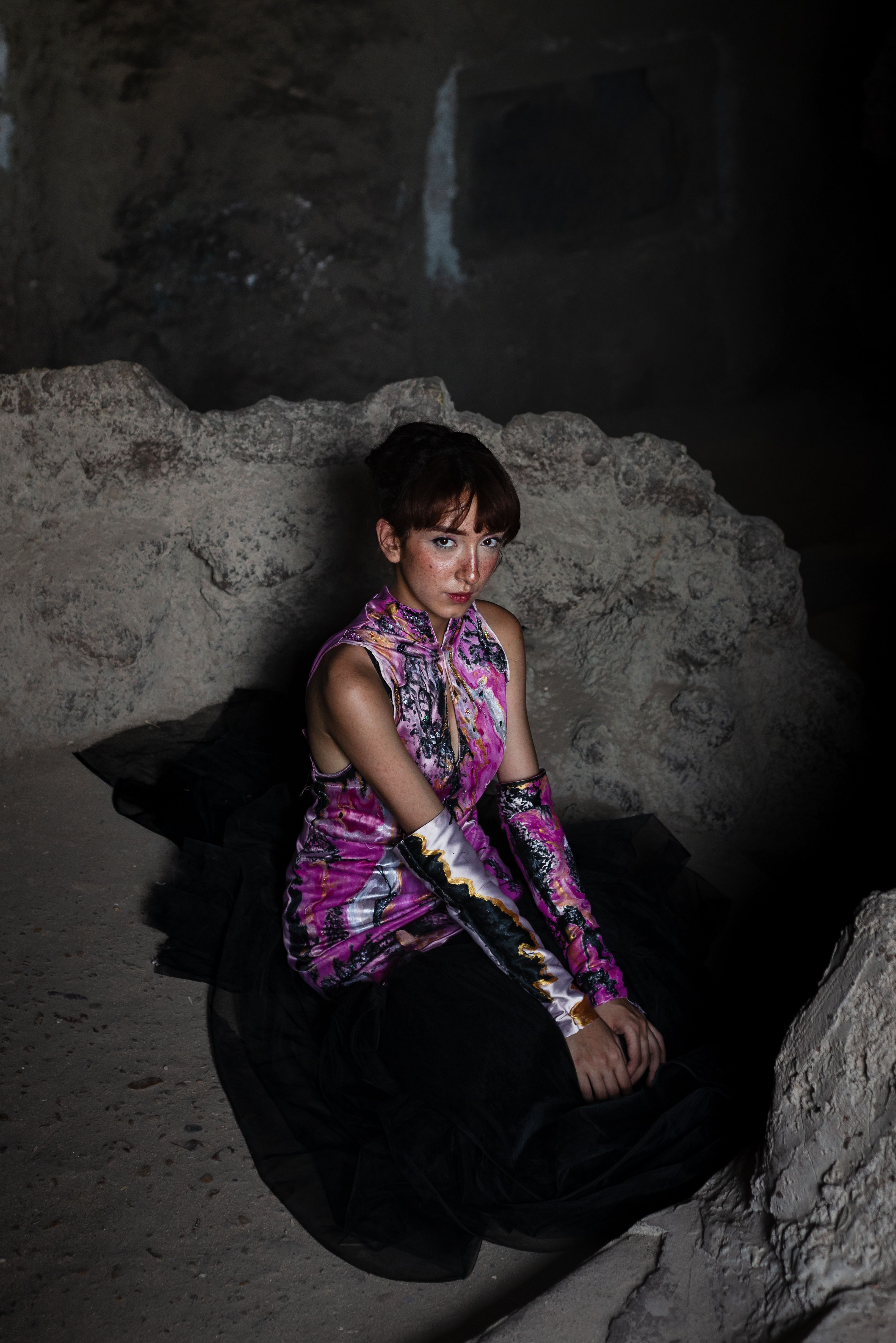 Artistic Portrait in Dimly Lit Cave Setting · Free Stock Photo