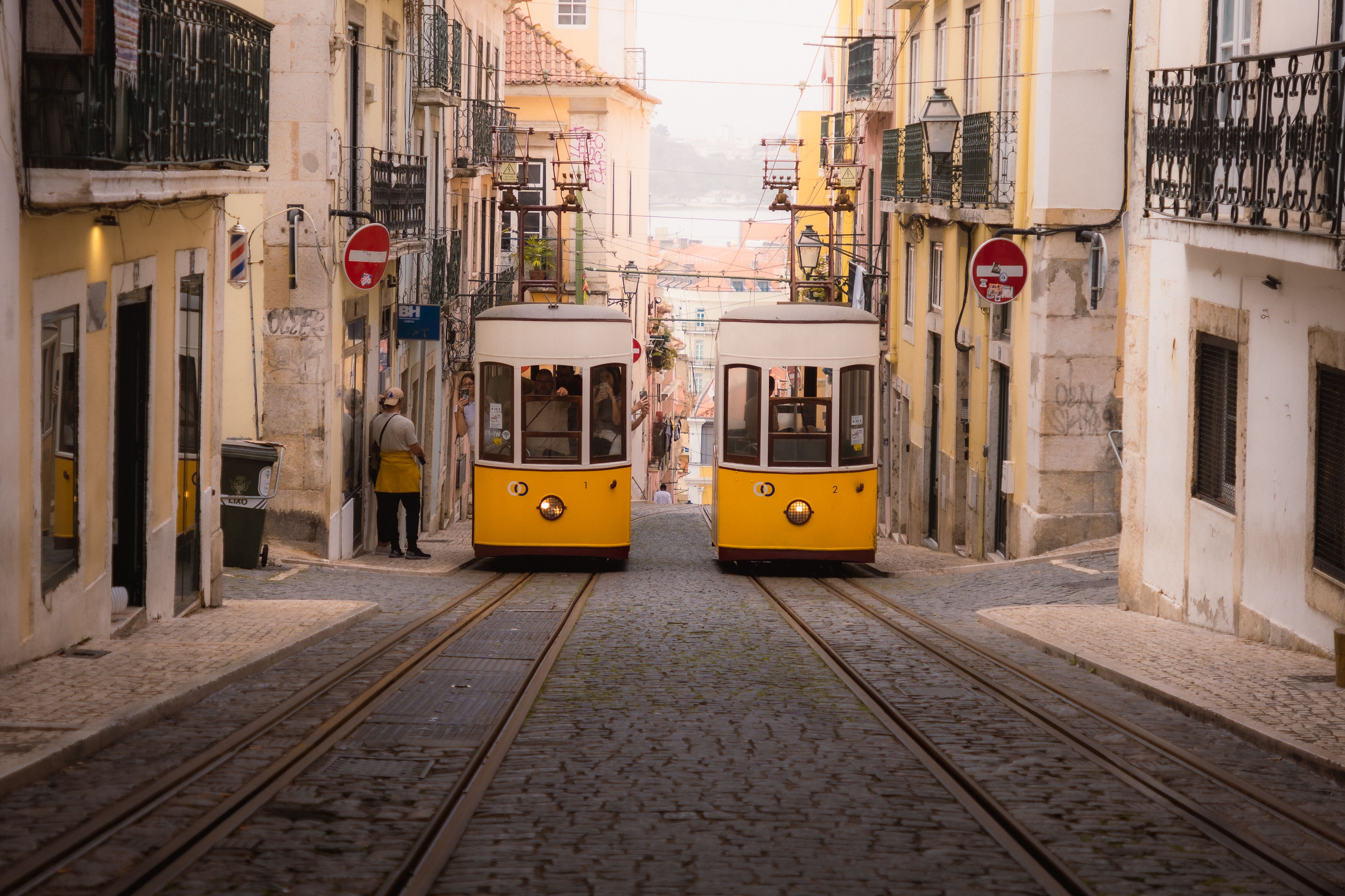 Vintage Yellow Trams on Lisbon's Historic Streets · Free Stock Photo