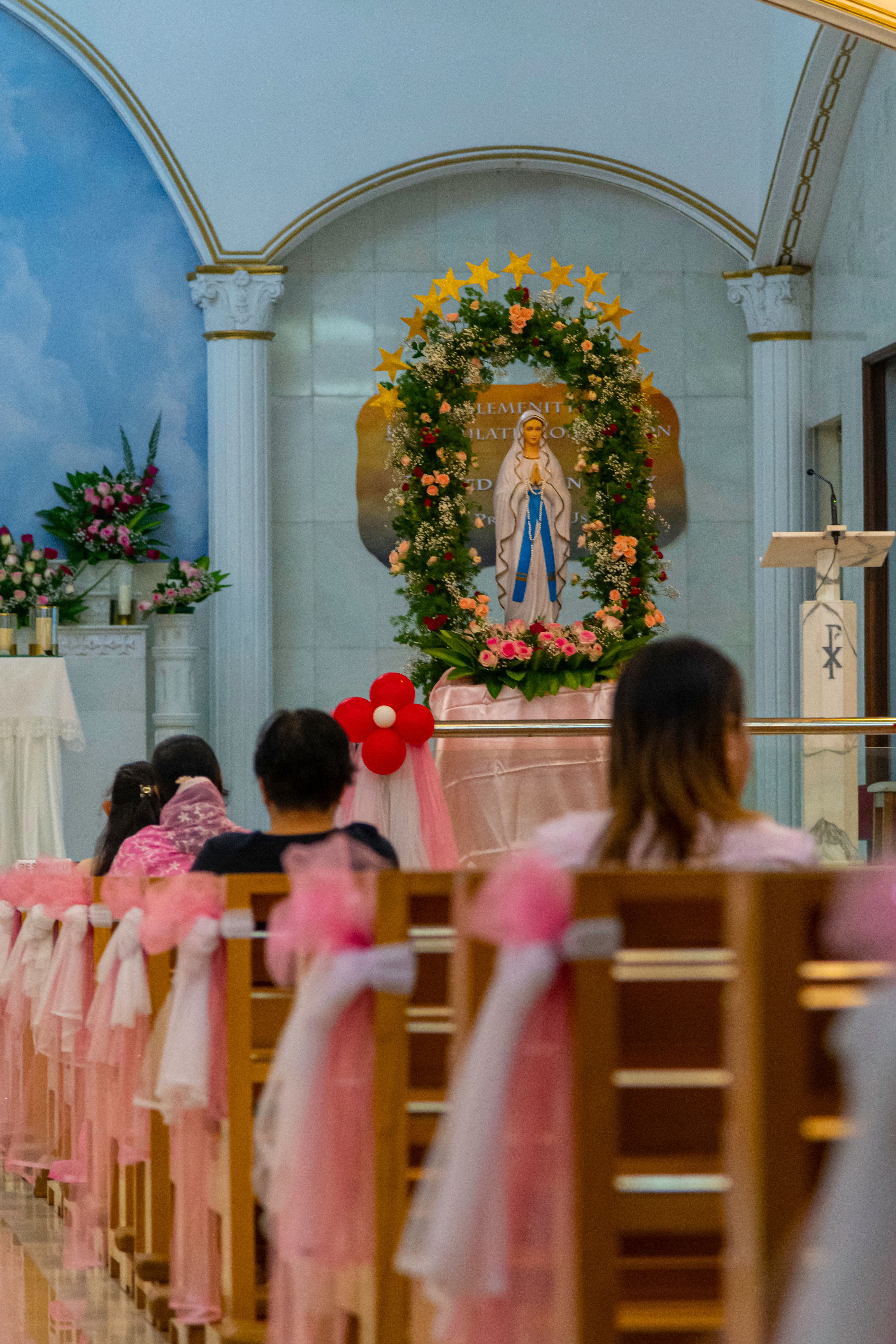 Catholic Church Ceremony with Floral Decorations · Free Stock Photo
