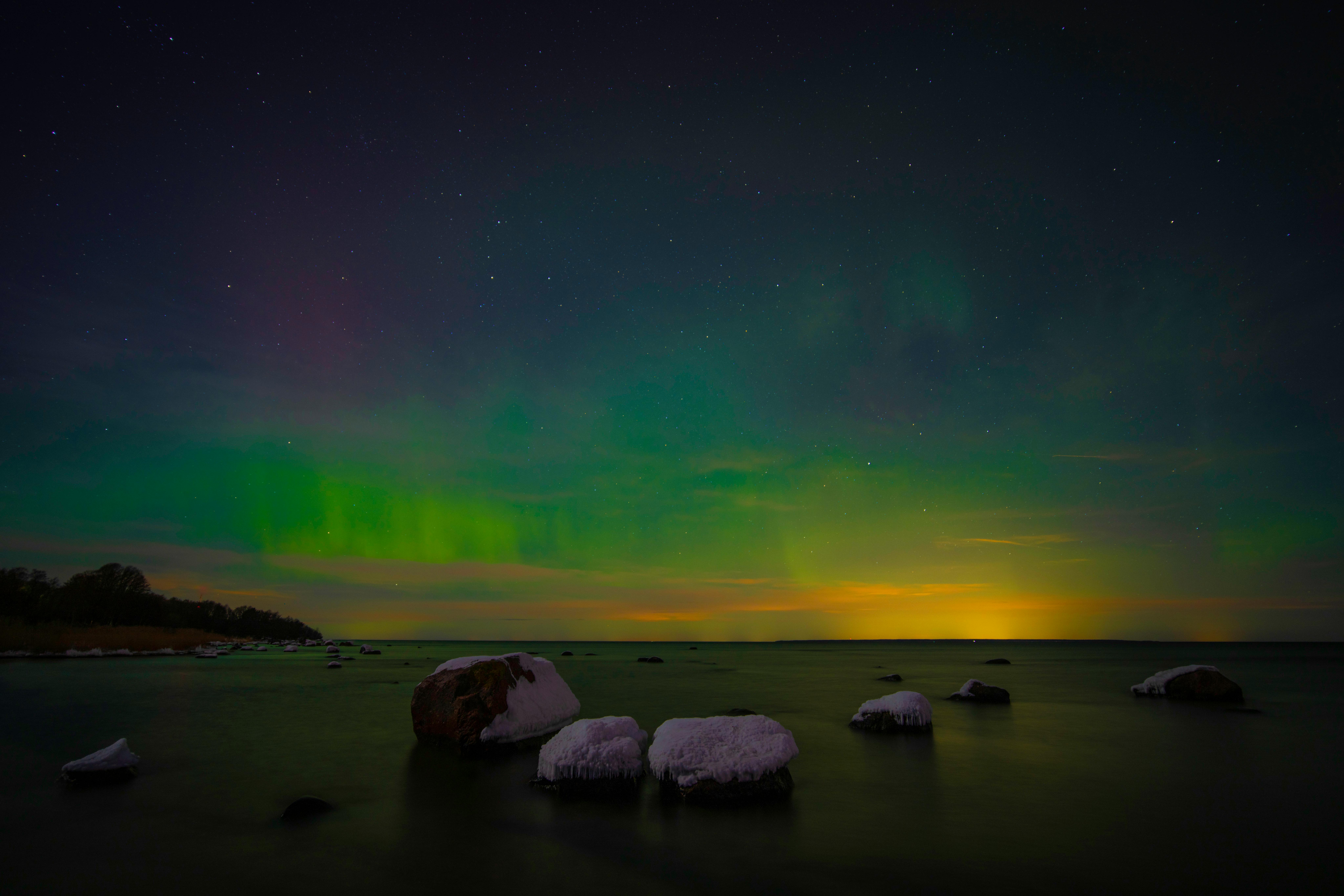 Stunning Aurora Borealis Over Rocky Waterscape at Night · Free Stock Photo