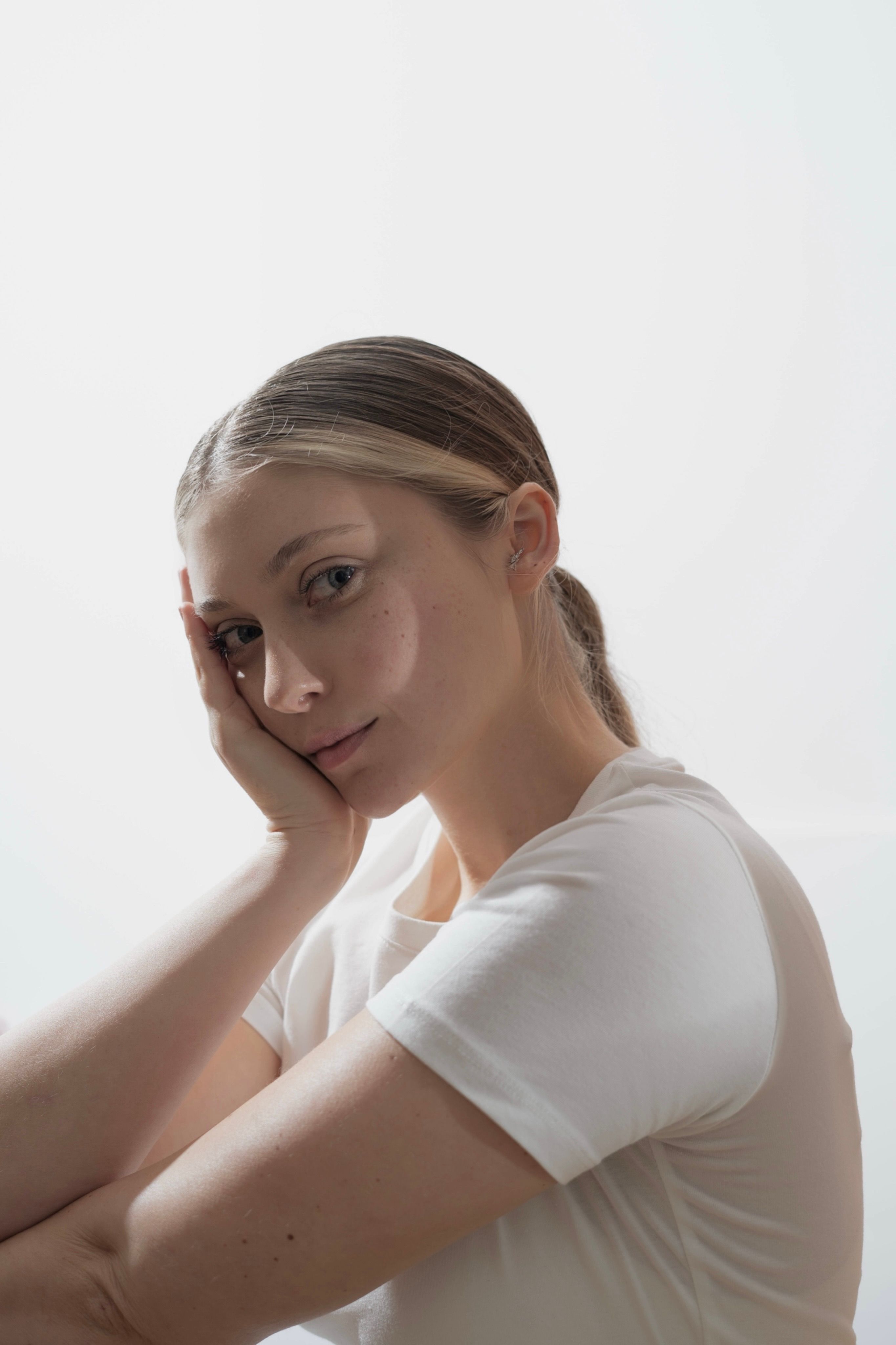 Contemplative Woman in Soft Natural Light · Free Stock Photo