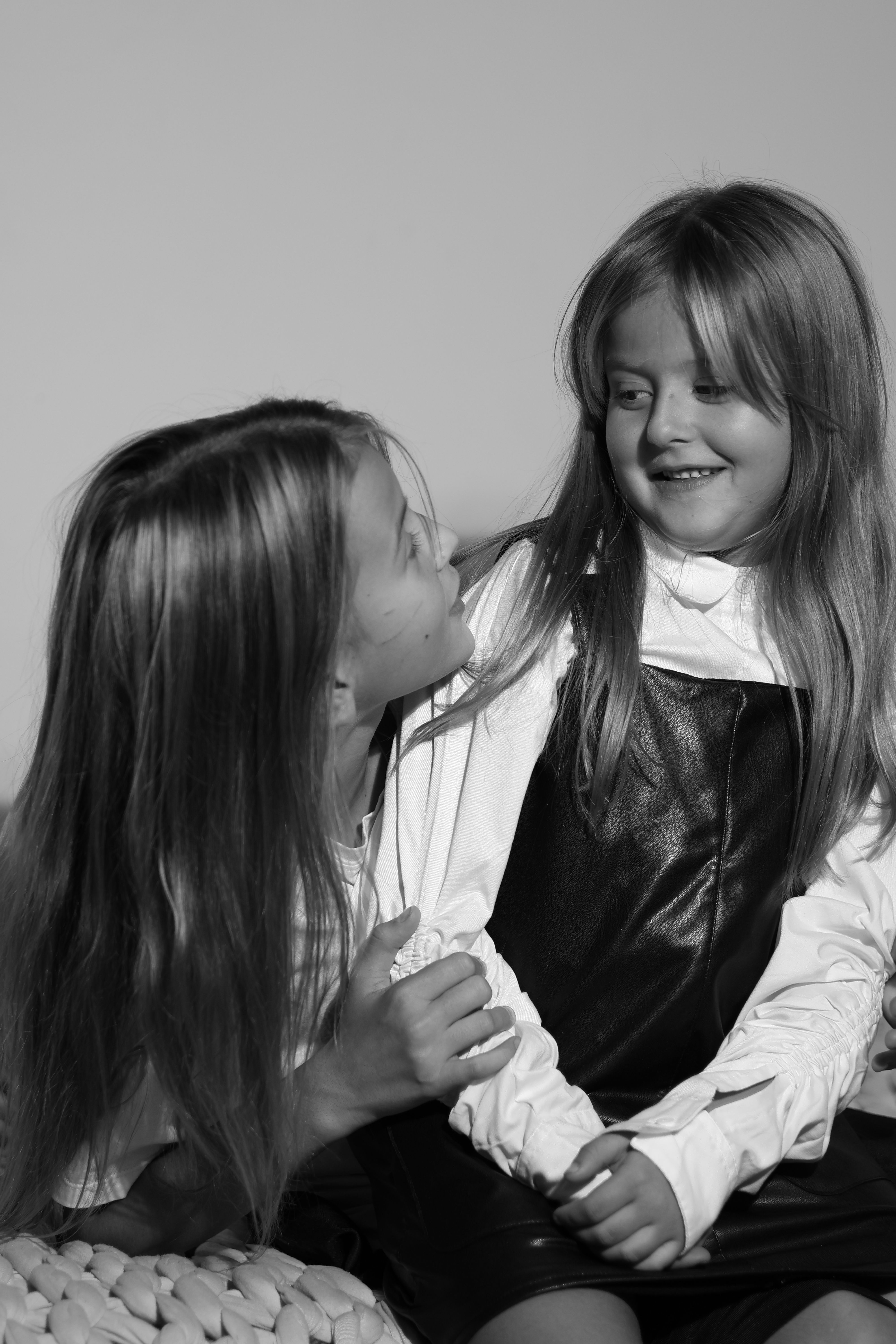 Joyful Sisterhood: Two Girls Sharing a Laugh · Free Stock Photo