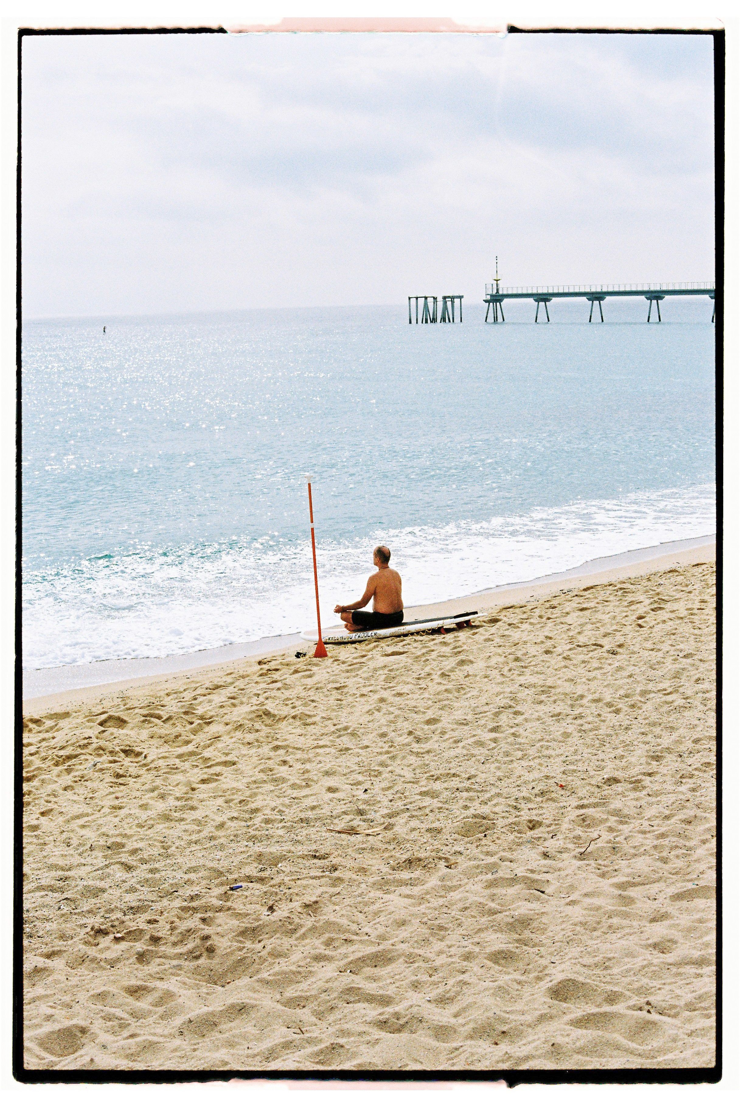 Serene Beach Scene with Sunbather · Free Stock Photo