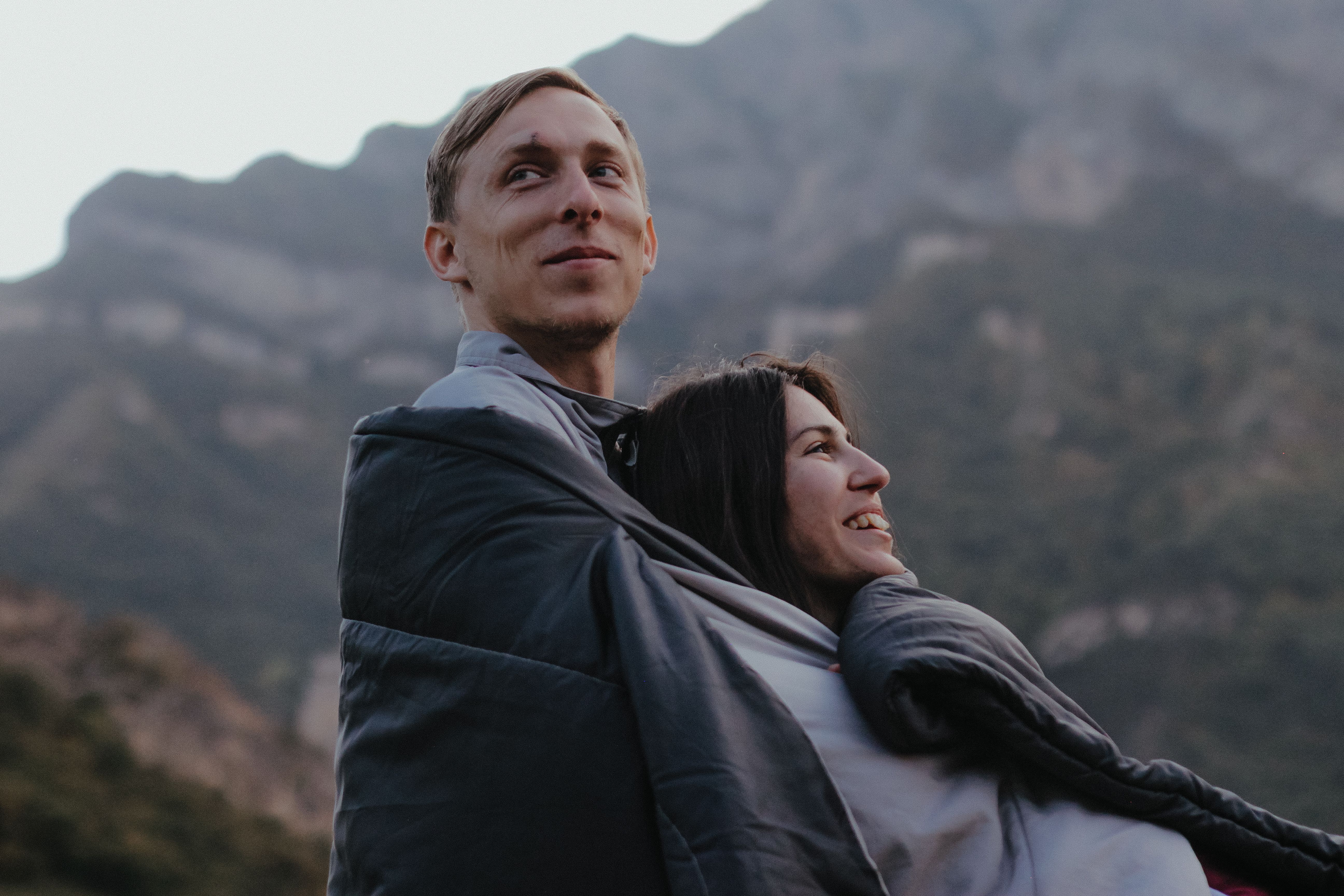 A Happy Couple Sharing a Blanket · Free Stock Photo