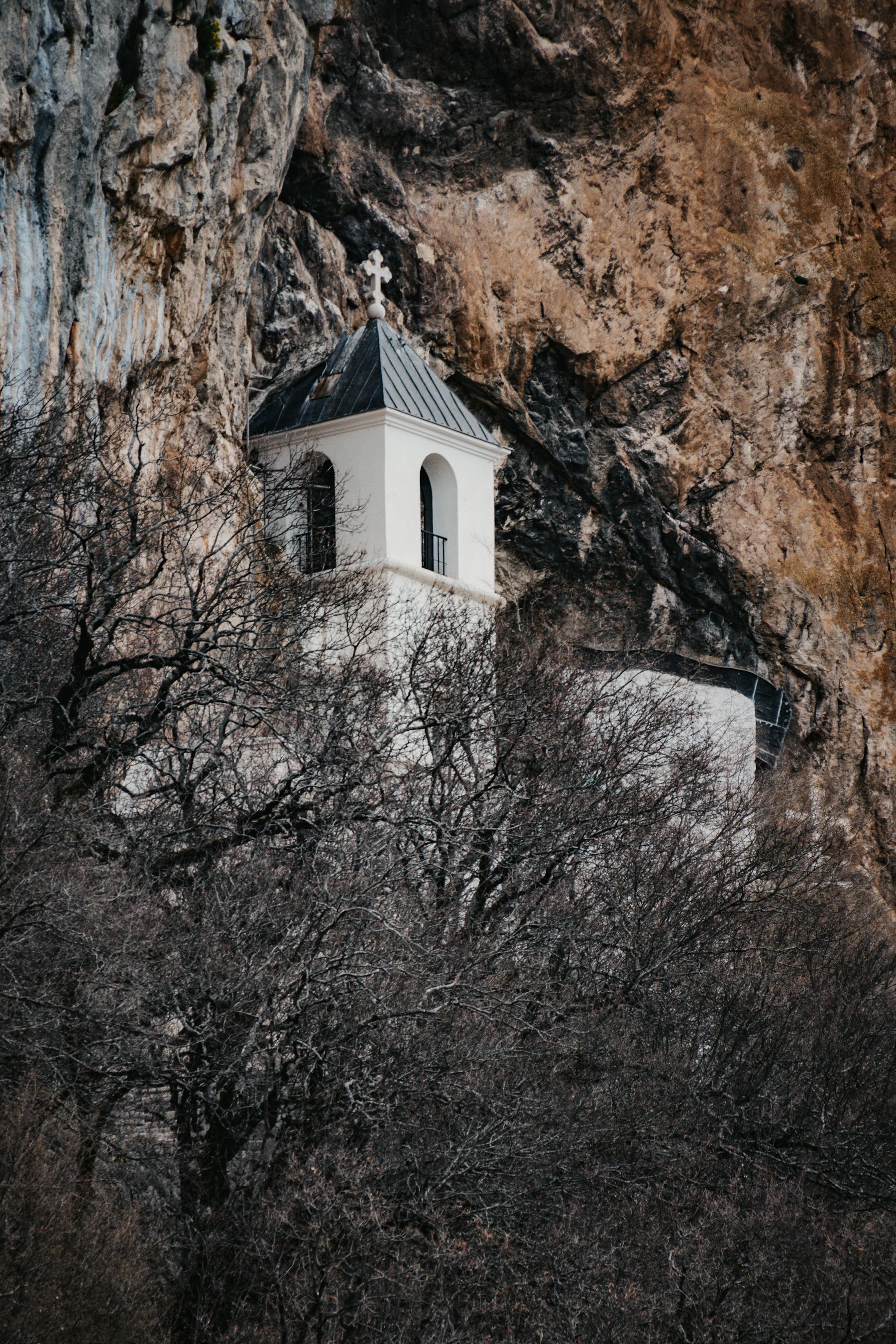 White Monastery Built into Rock Face in Montenegro · Free Stock Photo