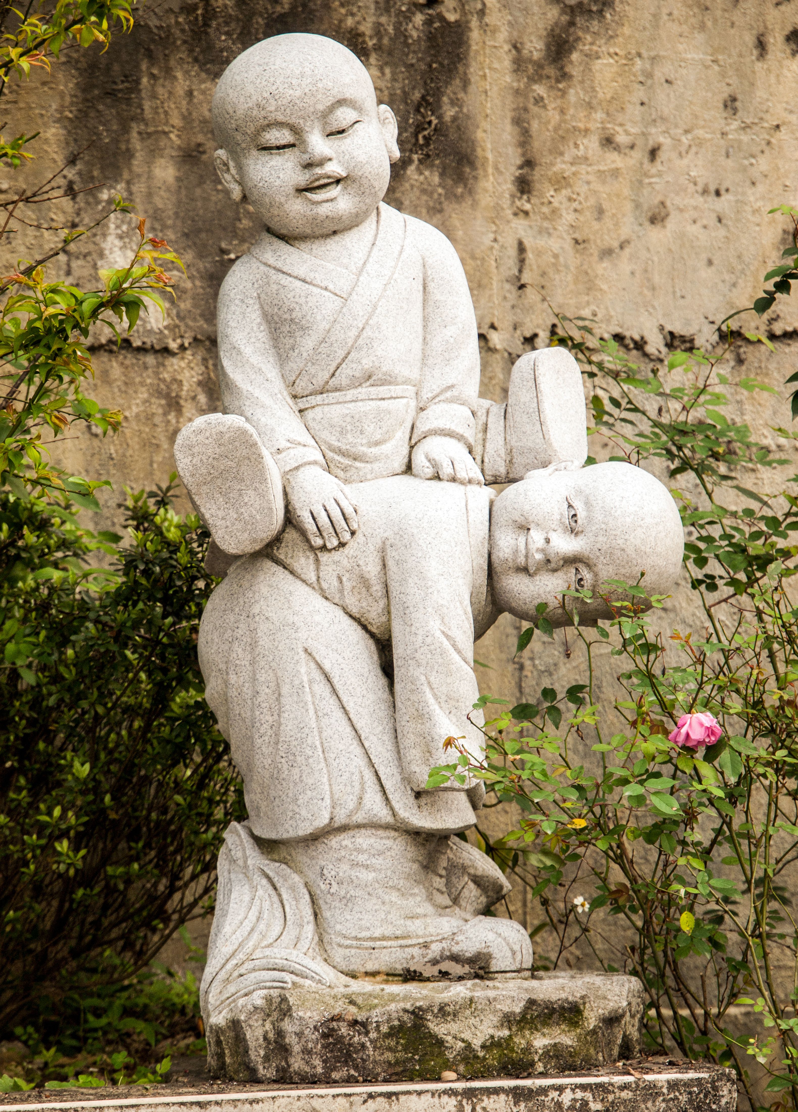 Stone Buddhist Monk Statues in Garden Setting · Free Stock Photo