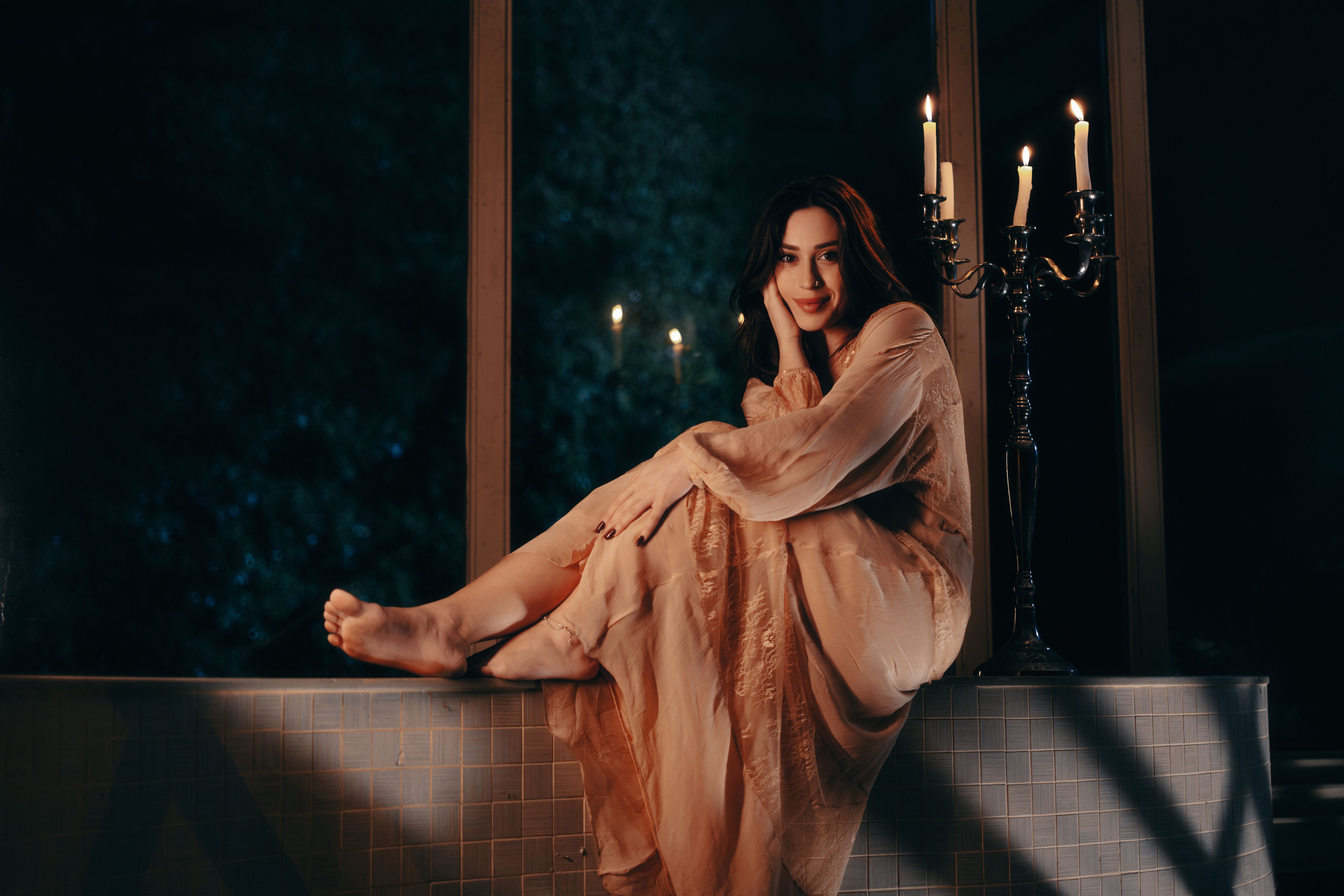 Elegant Woman Relaxing by Candlelight at Night · Free Stock Photo