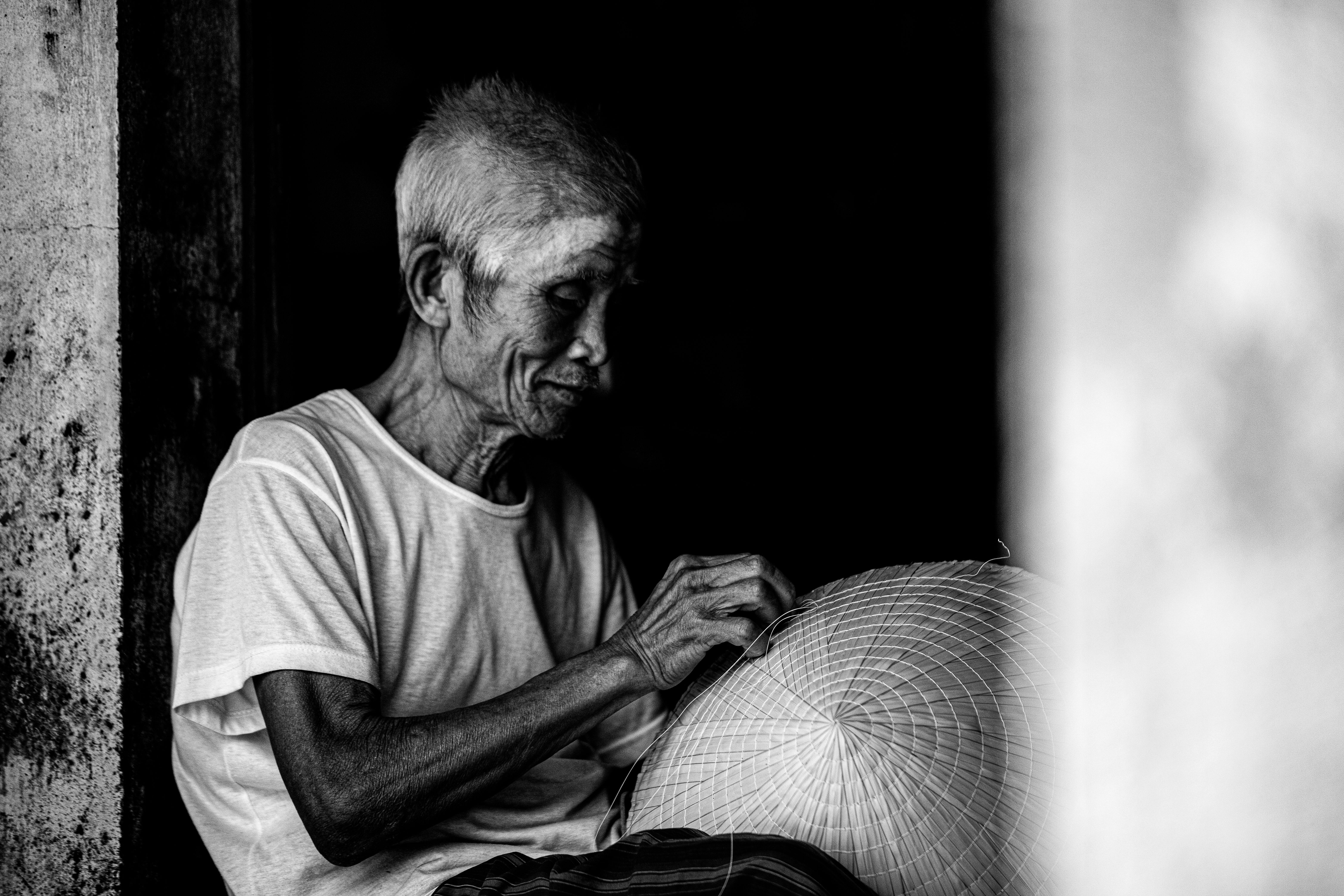 Elderly Man with Hat Holding String · Free Stock Photo