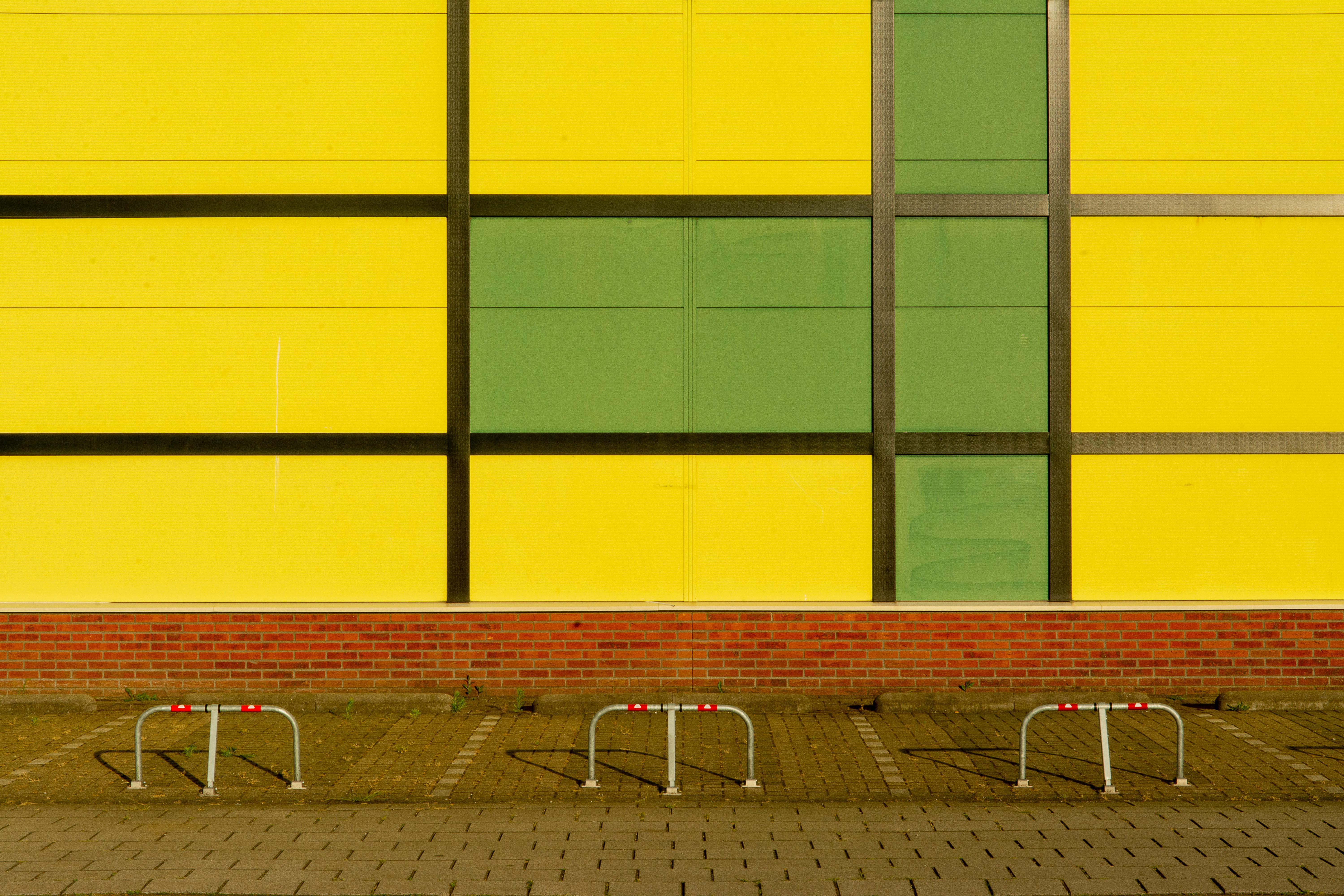 Colorful Urban Building Facade with Bike Racks · Free Stock Photo