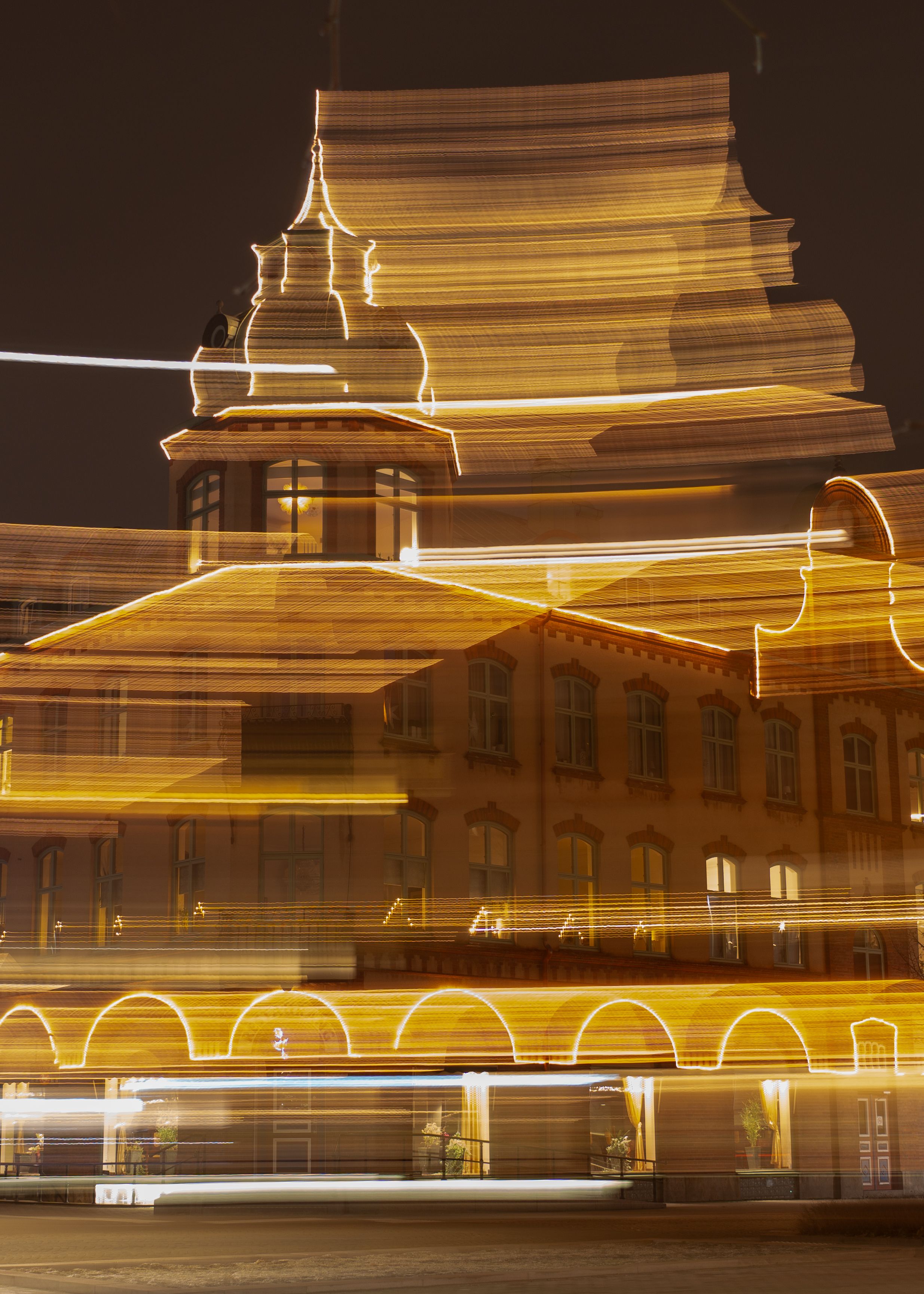 Illuminated Building with Light Trails at Night · Free Stock Photo