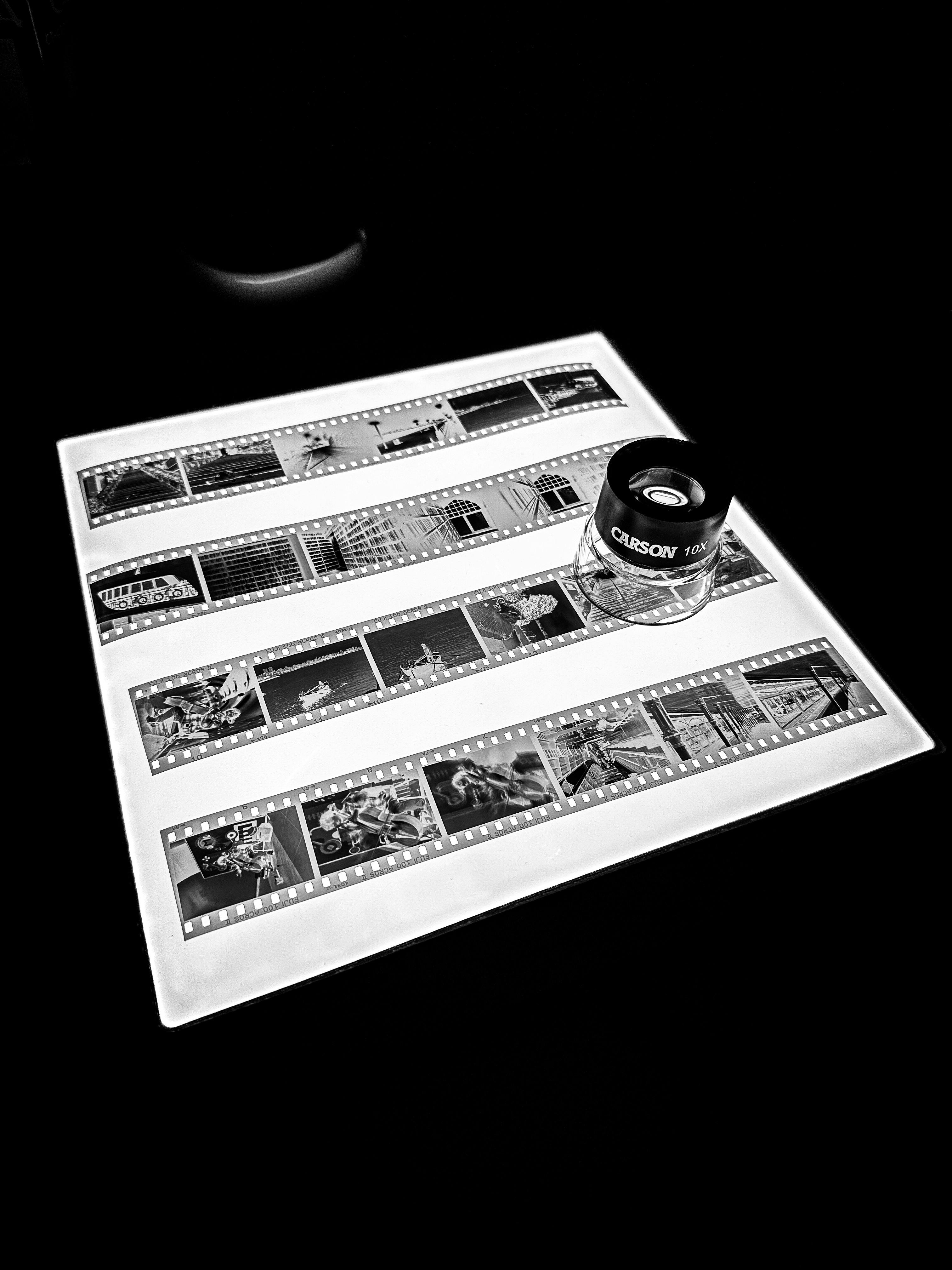 Black and White Film Negatives with Loupe · Free Stock Photo