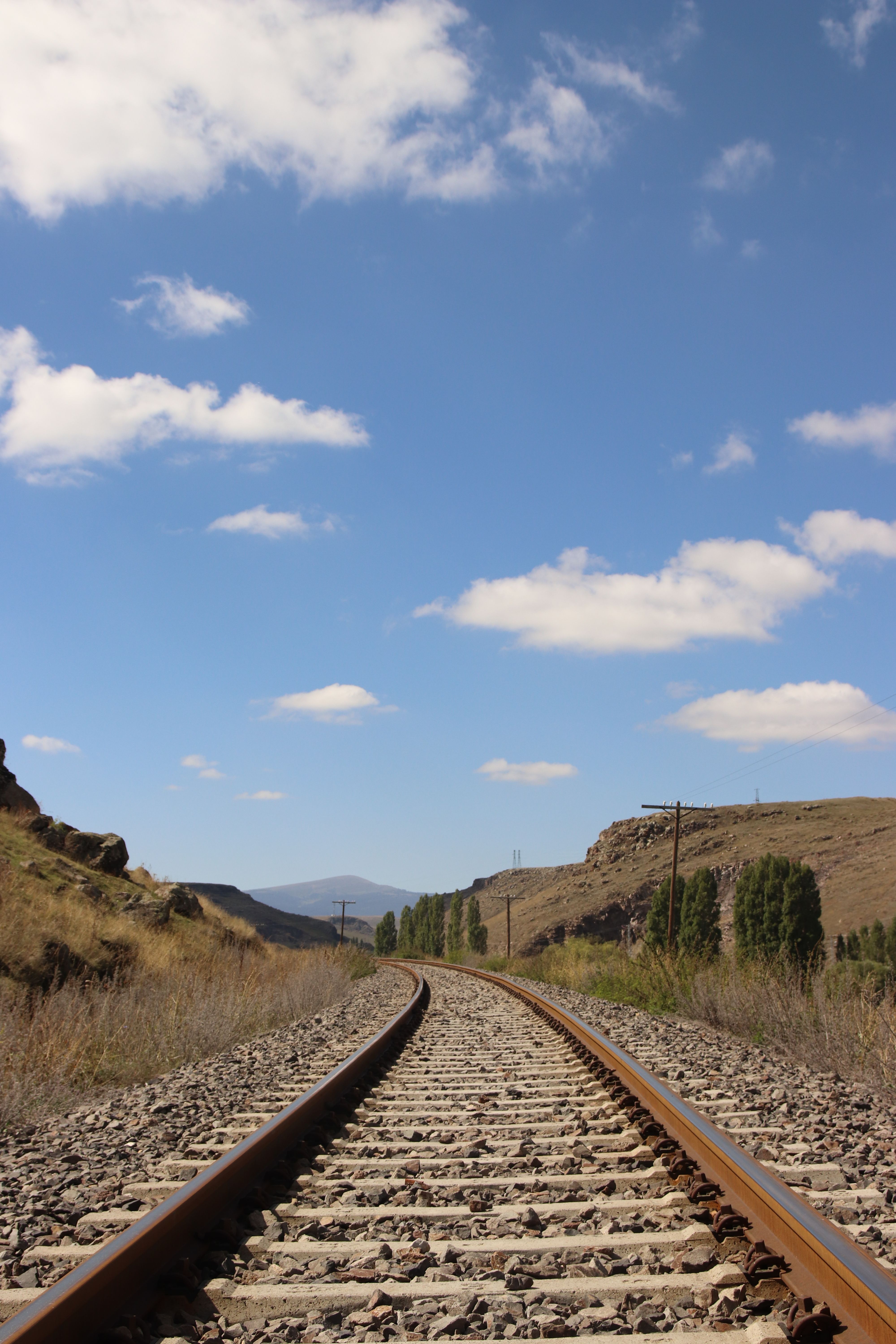 Serene Railway Track in Scenic Mountain Landscape · Free Stock Photo