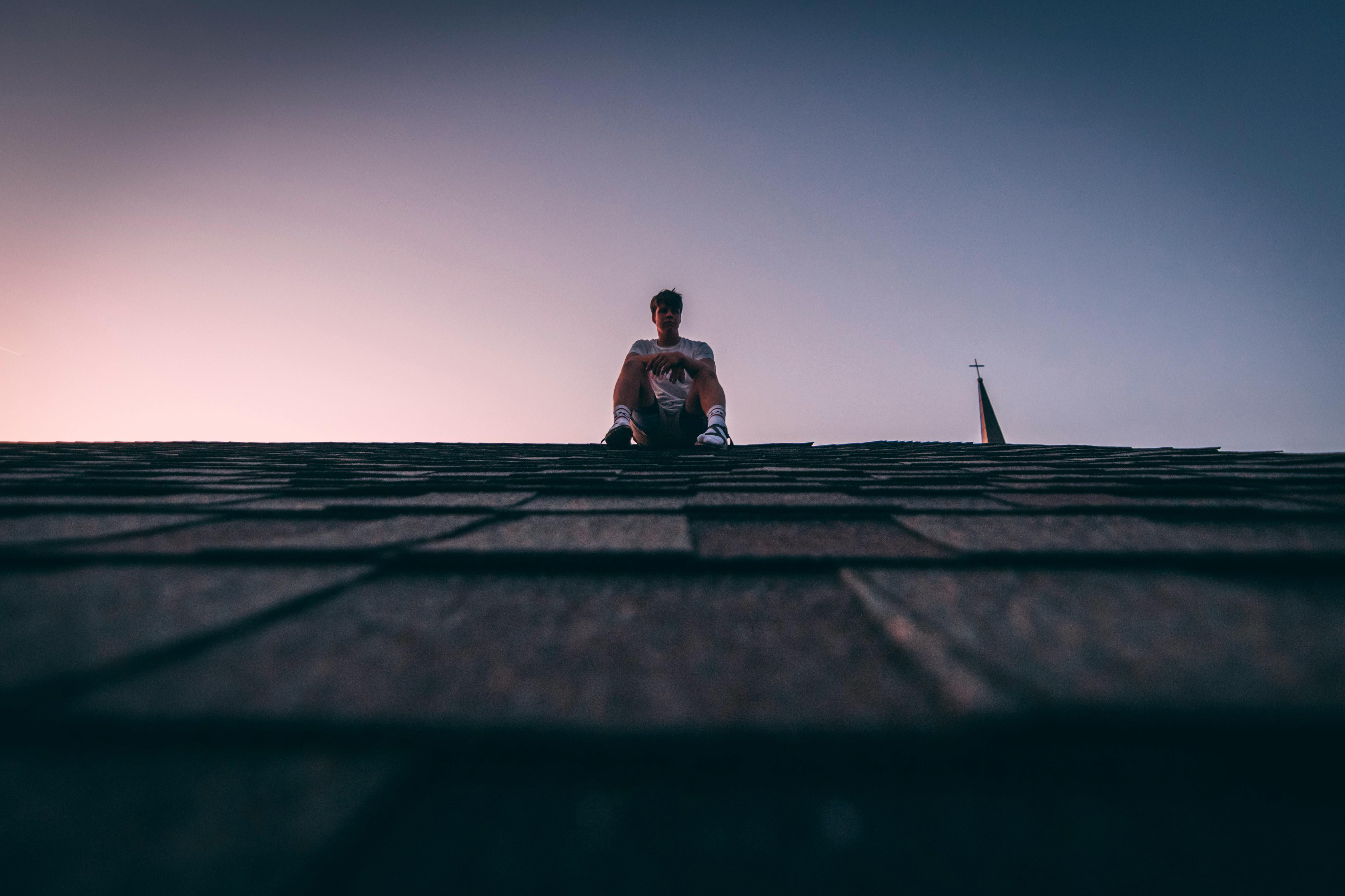 Man Sitting On Roof · Free Stock Photo