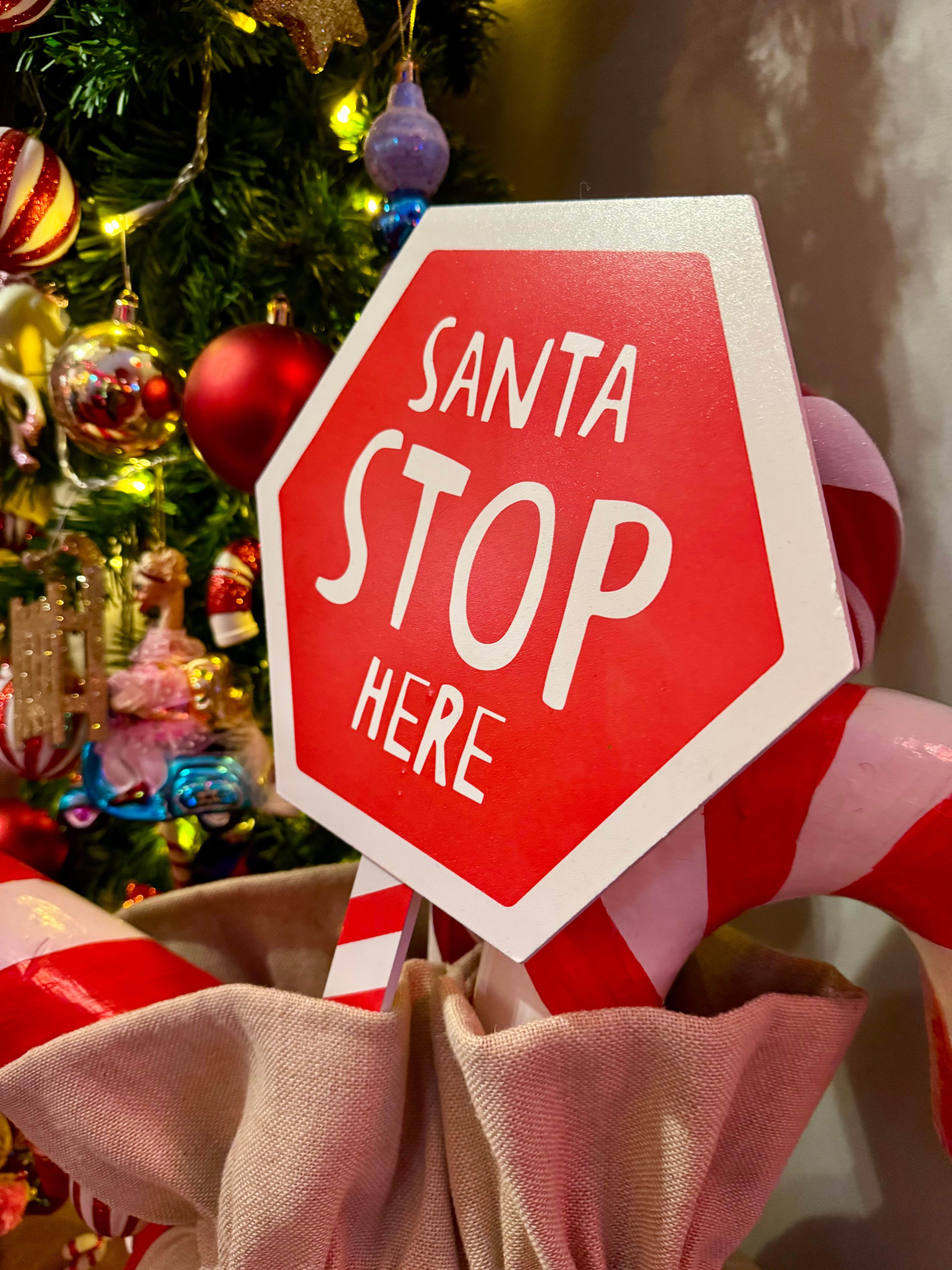Festive Santa Stop Sign with Christmas Tree Decor · Free Stock Photo