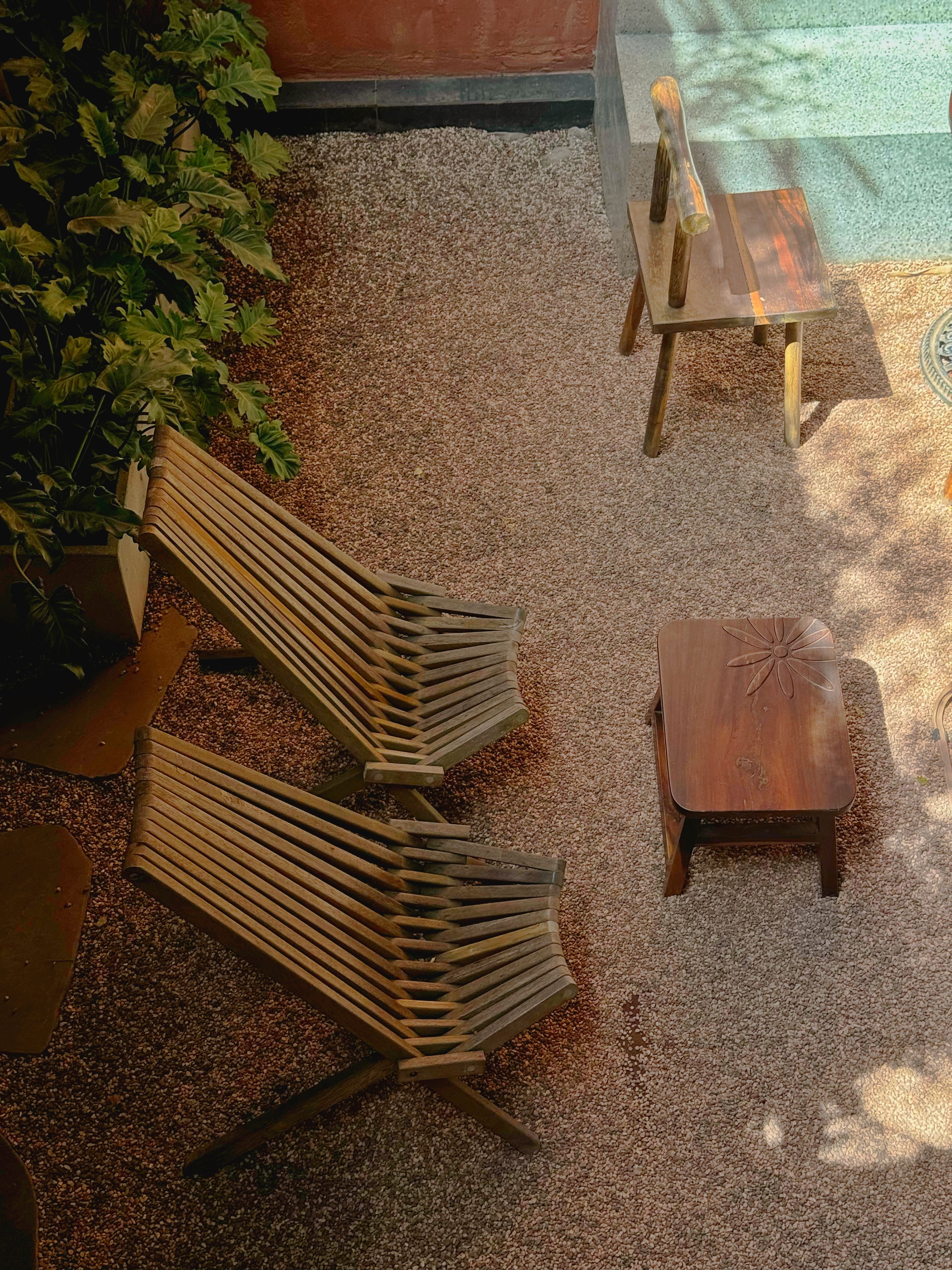 Outdoor Patio with Wooden Furniture and Gravel Path · Free Stock Photo