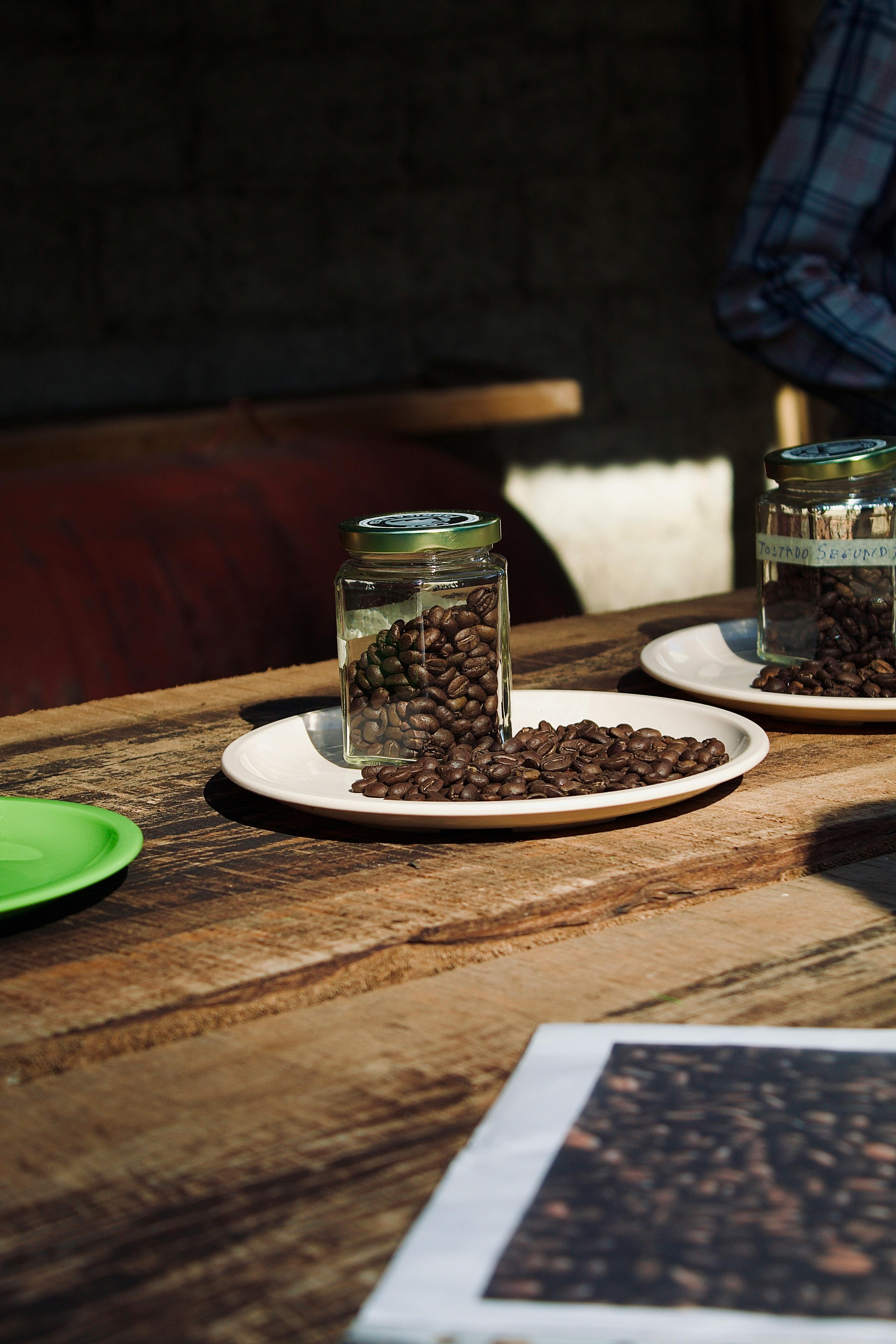 Coffee Beans Display on Rustic Wooden Table · Free Stock Photo